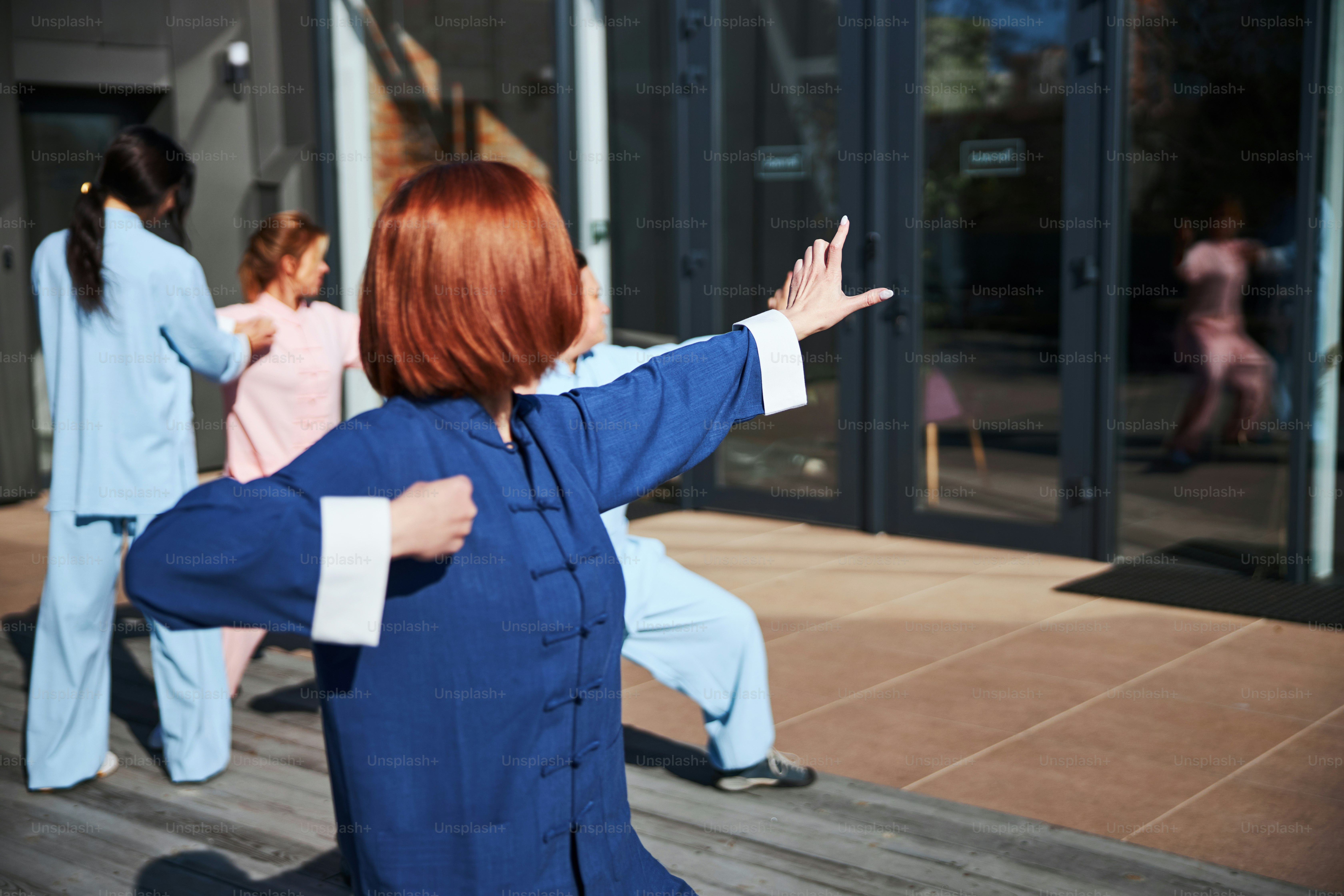 Group of people working out with traditional Chinese martial arts and ...
