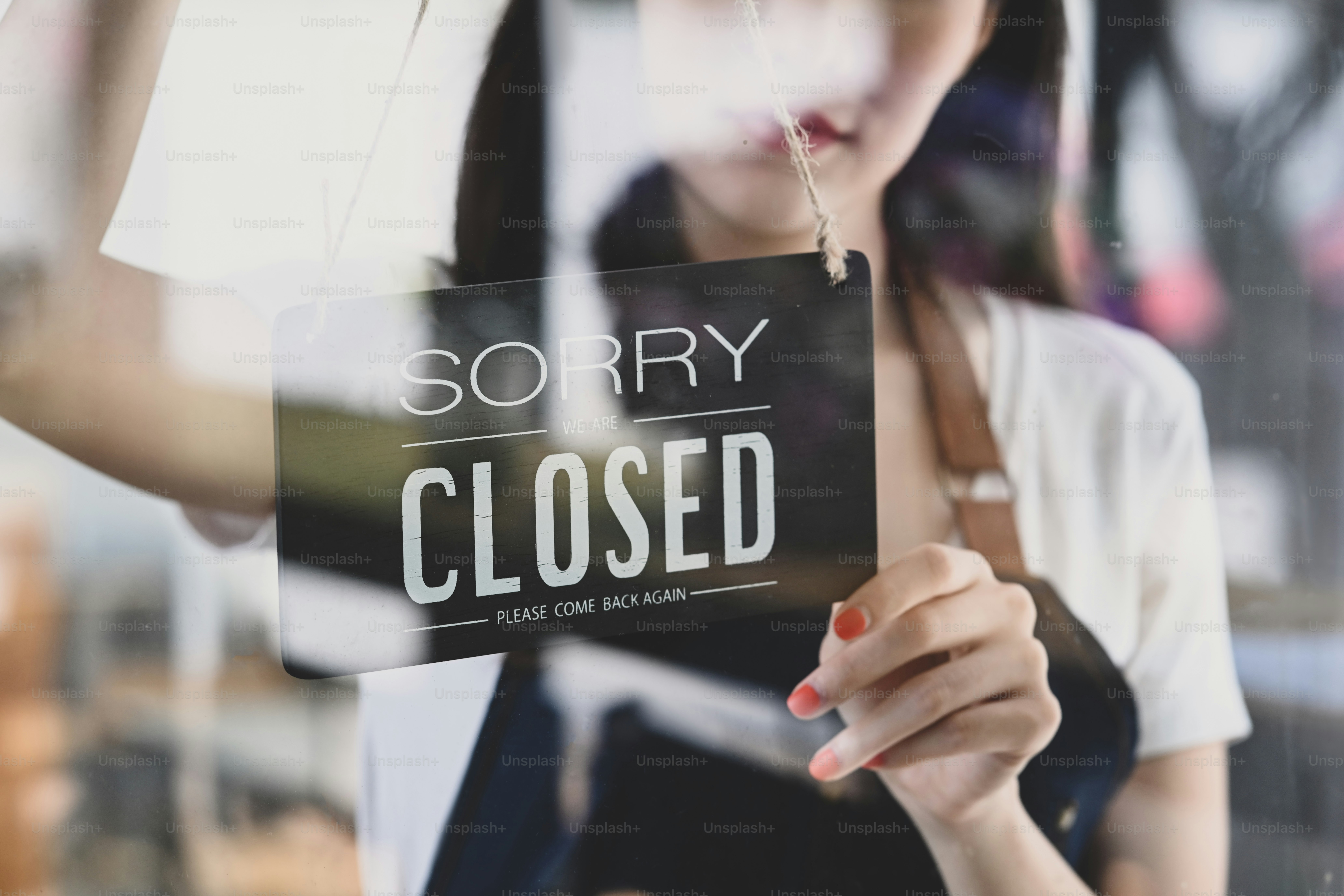 Woman coffee shop owner turning closed sign board on glass door. photo ...