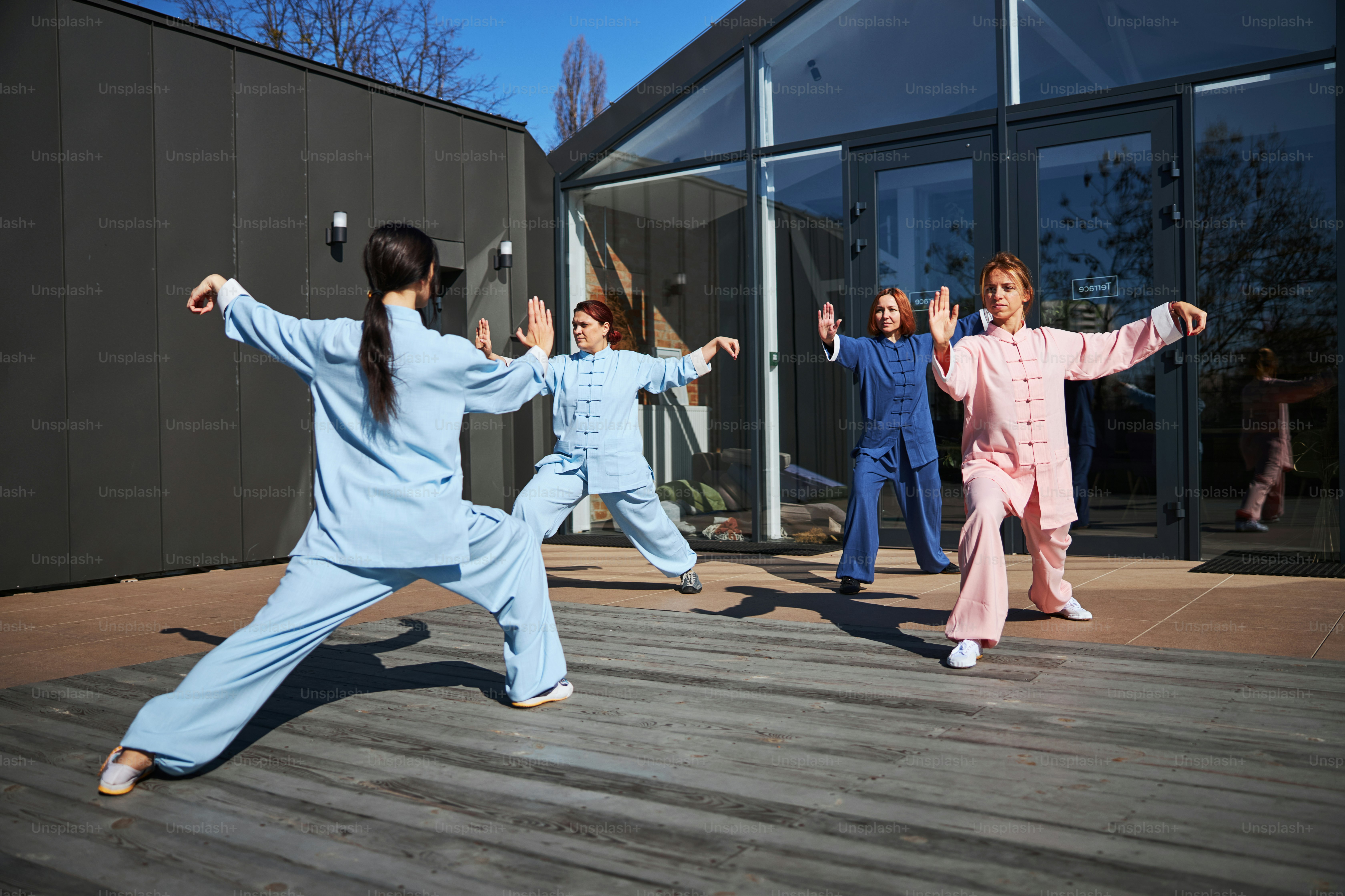 Several ladies doing their best while getting the philosophy of qigong ...