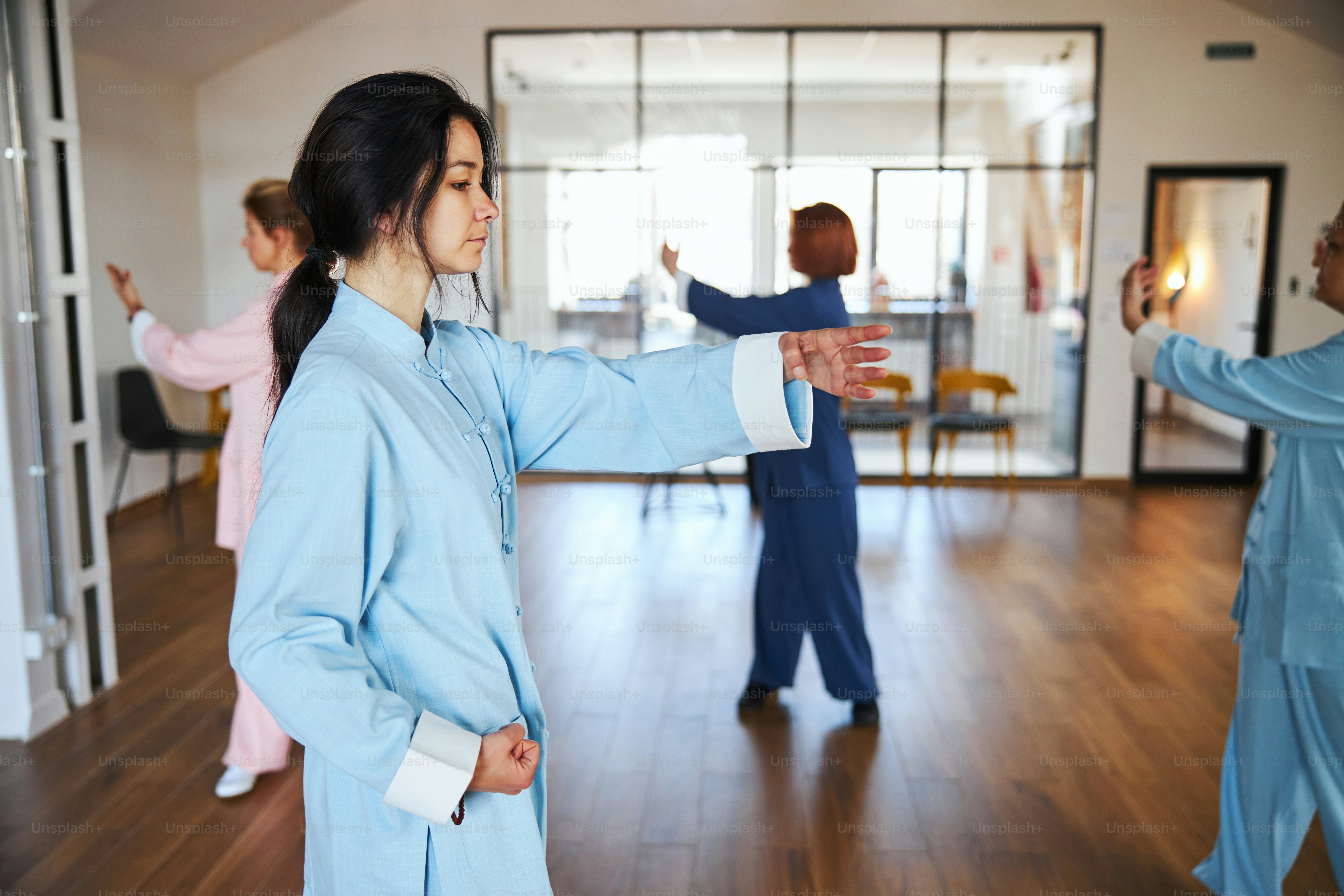 Group of people in Chinese clothes combining slow movements with ...