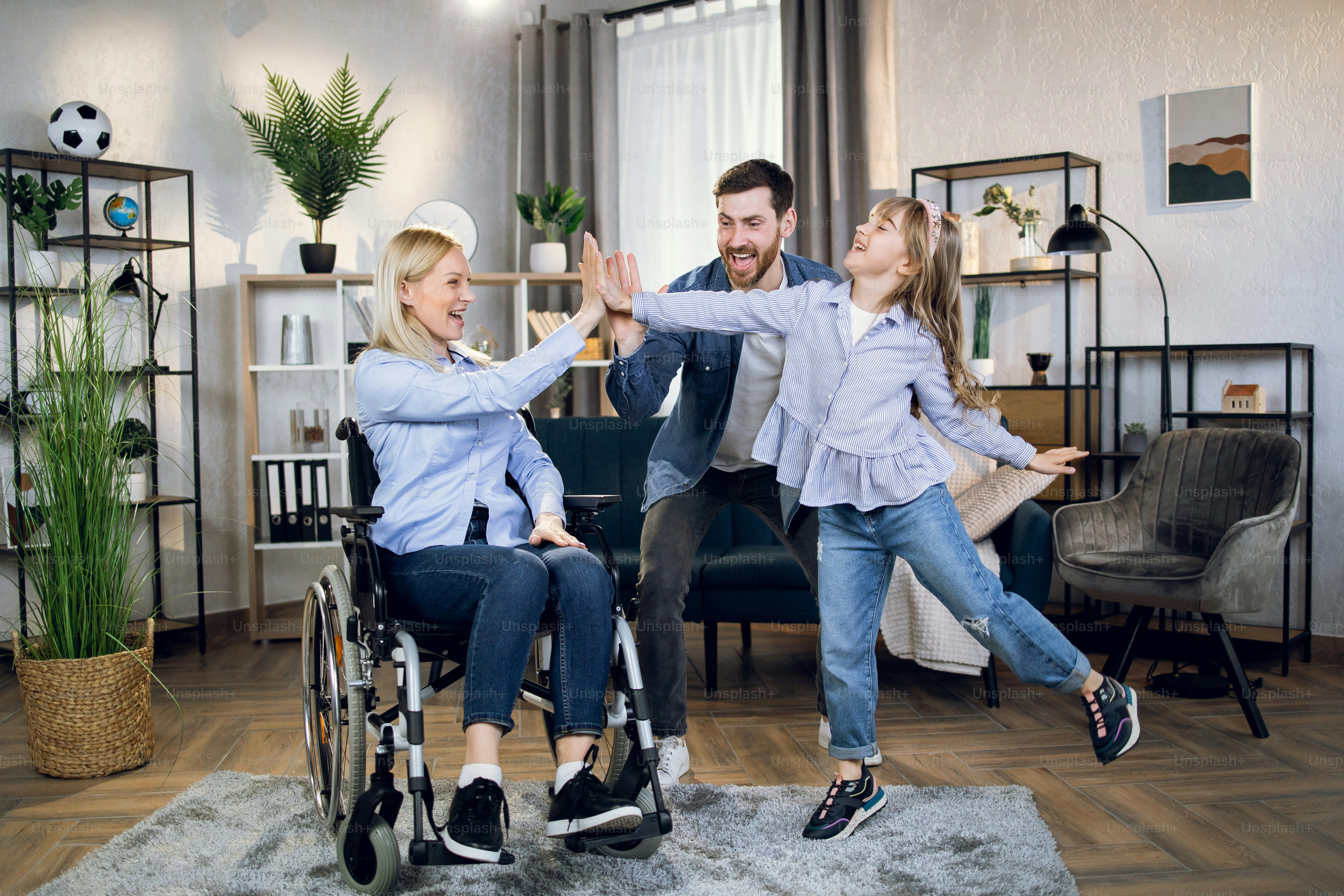 Handicapped woman with blond hair giving high five to handsome husband ...