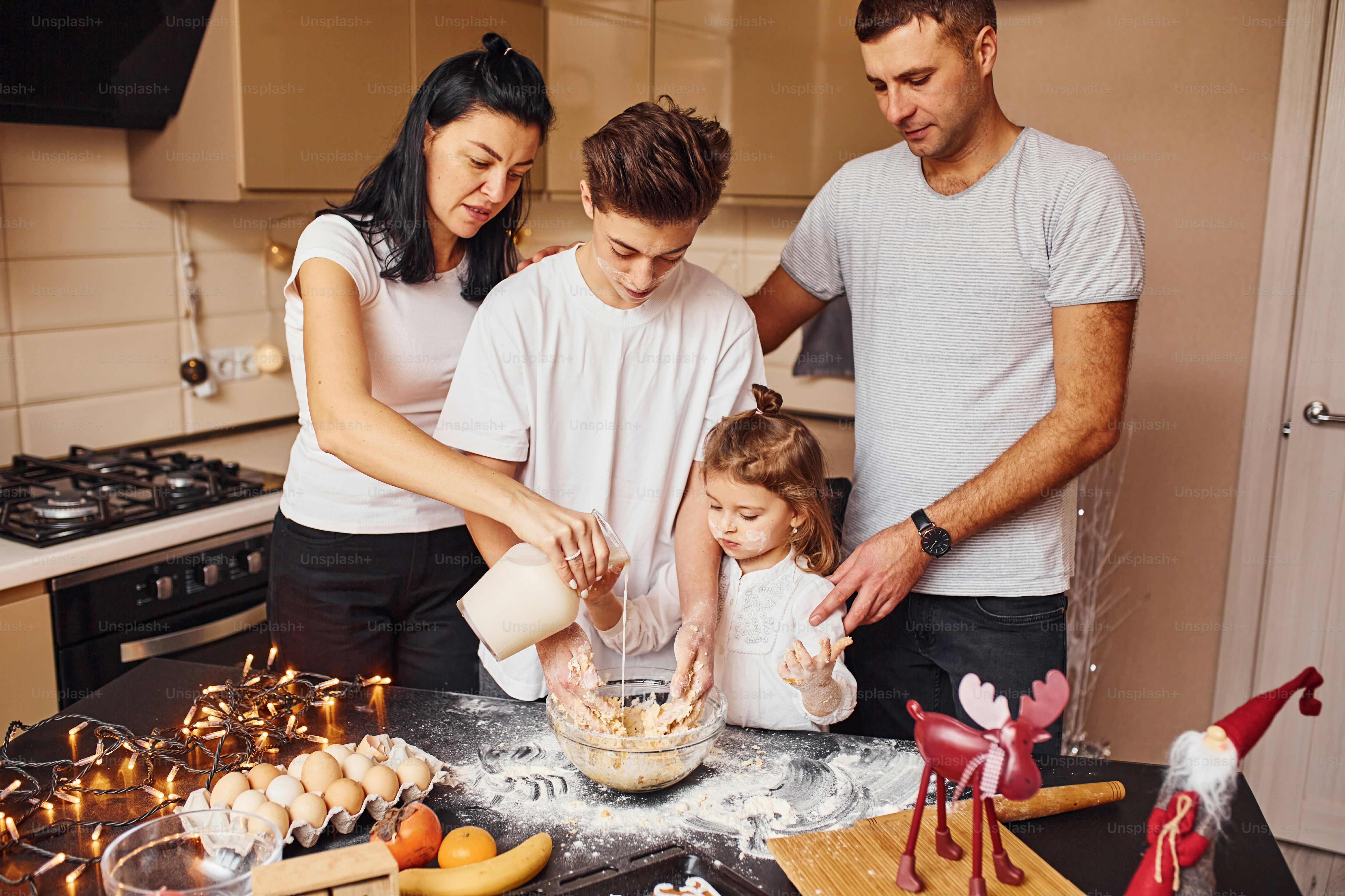 Happy family have fun on the kitchen and preparing food. photo – Joy ...