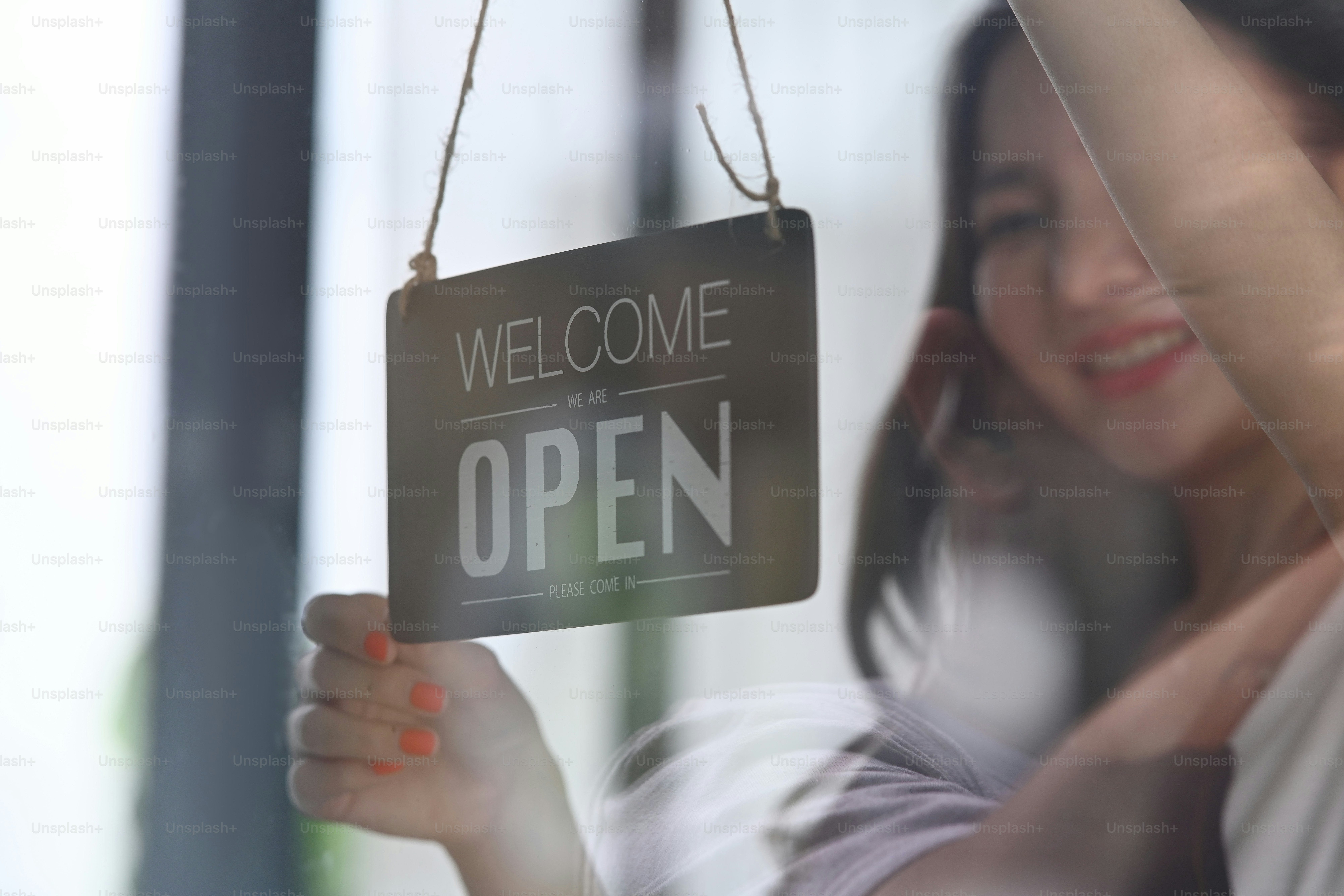 Small business owner turning open sign and ready to service. photo ...