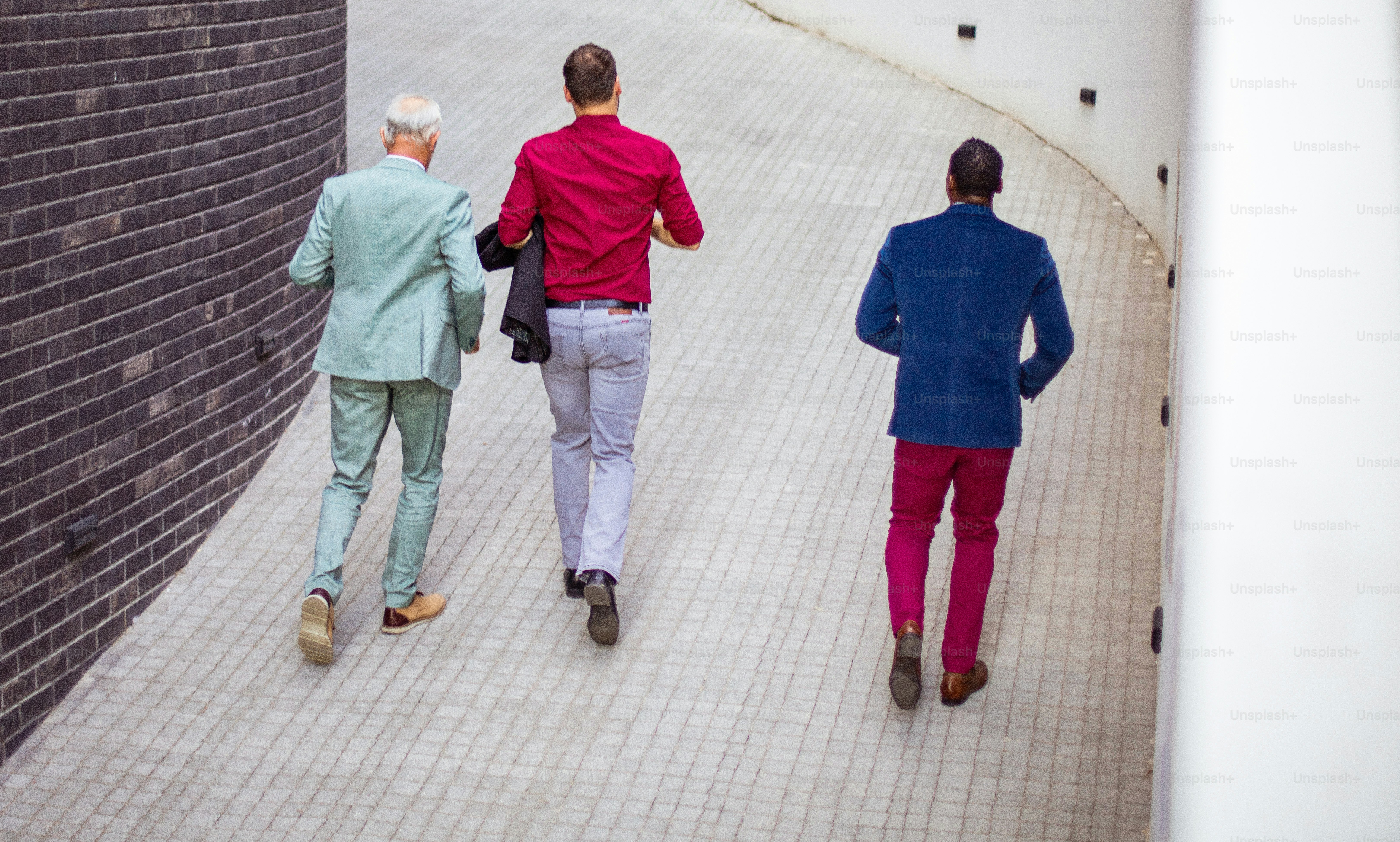 Three business men talking and walking. Running to work. Above view ...