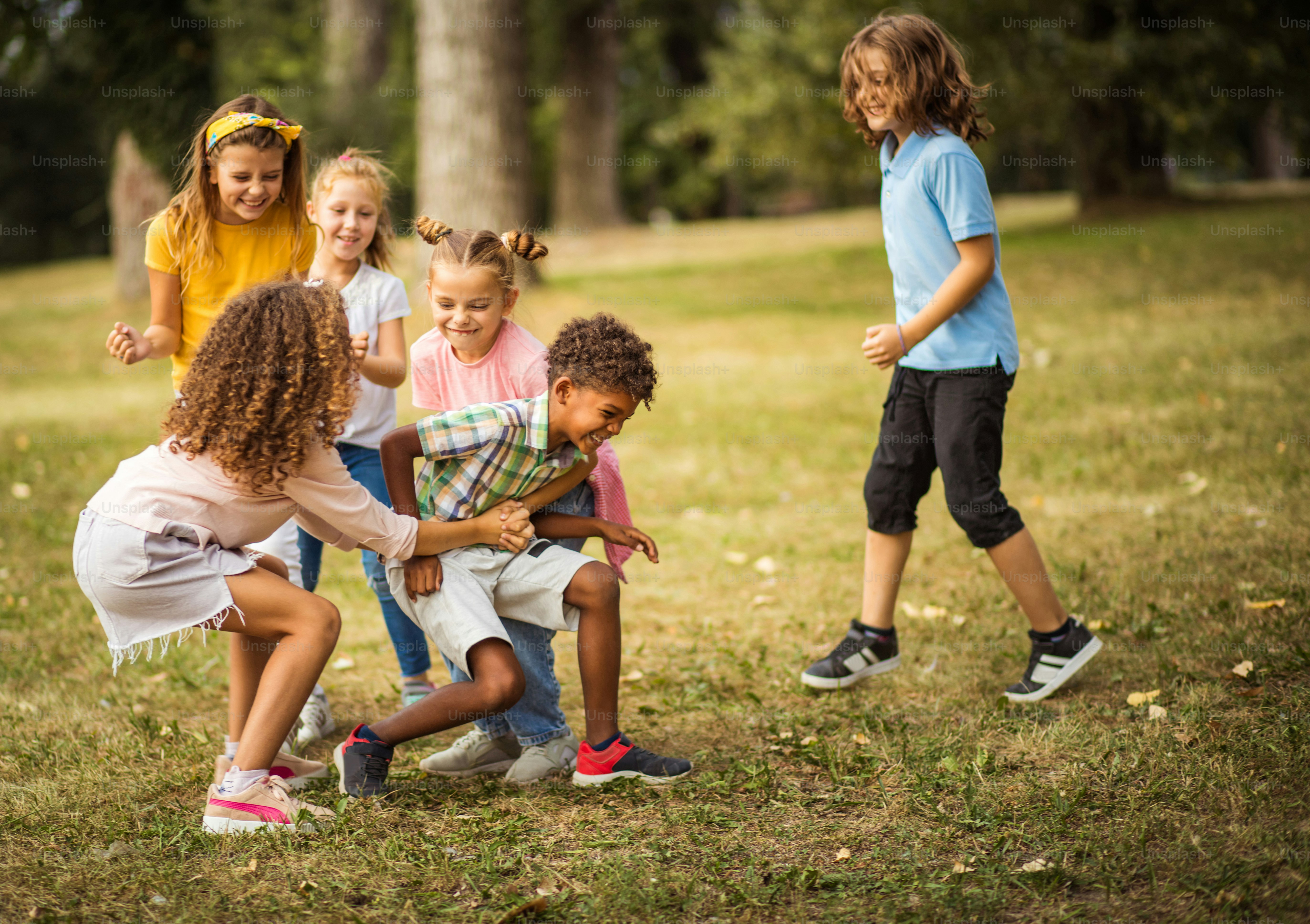 Play time in nature. Large group of school kids having fun in nature ...