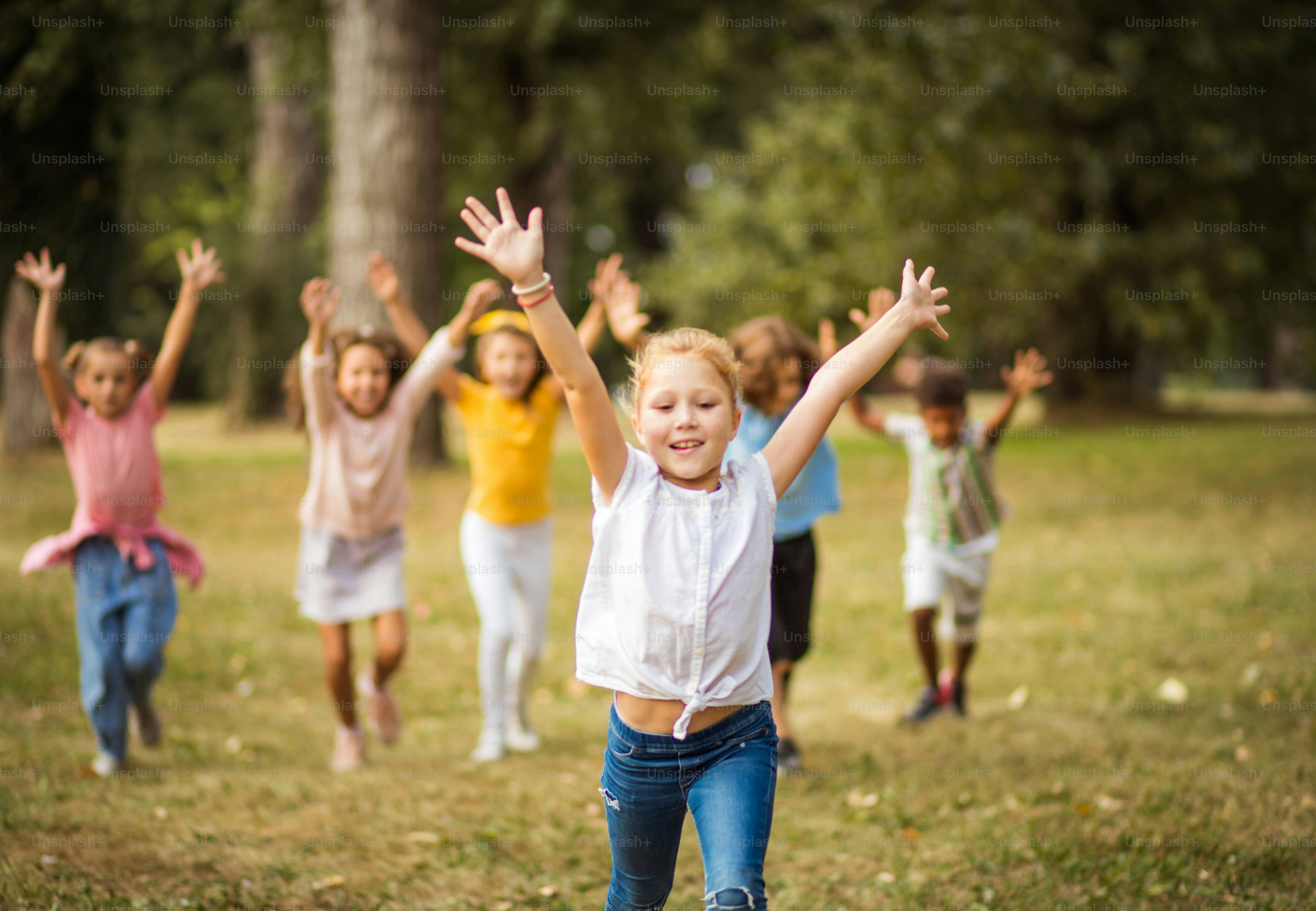 Bye, see you again. Large group of school kids having fun in nature ...