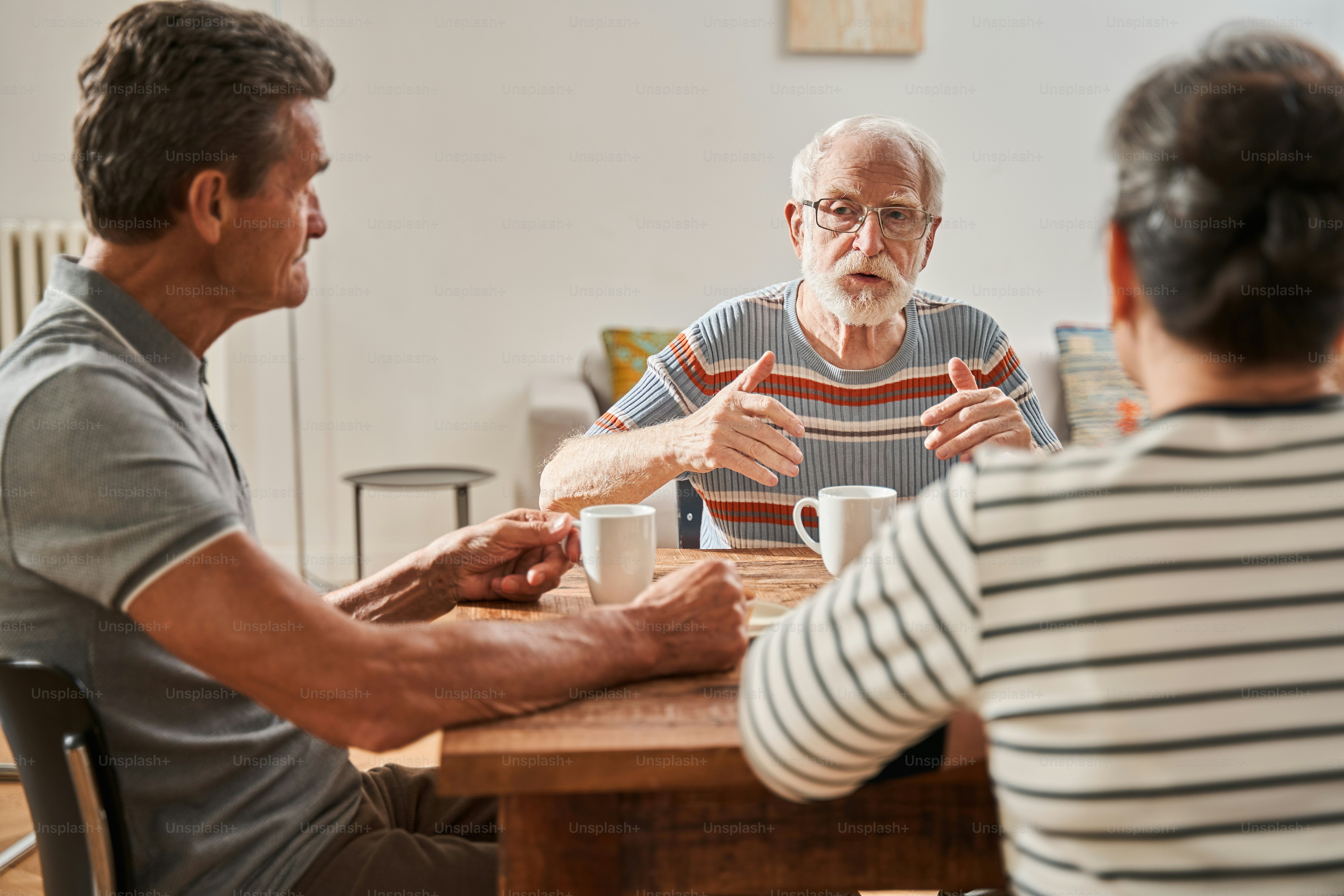 My memories. Three retirement people sitting at the table at the living ...