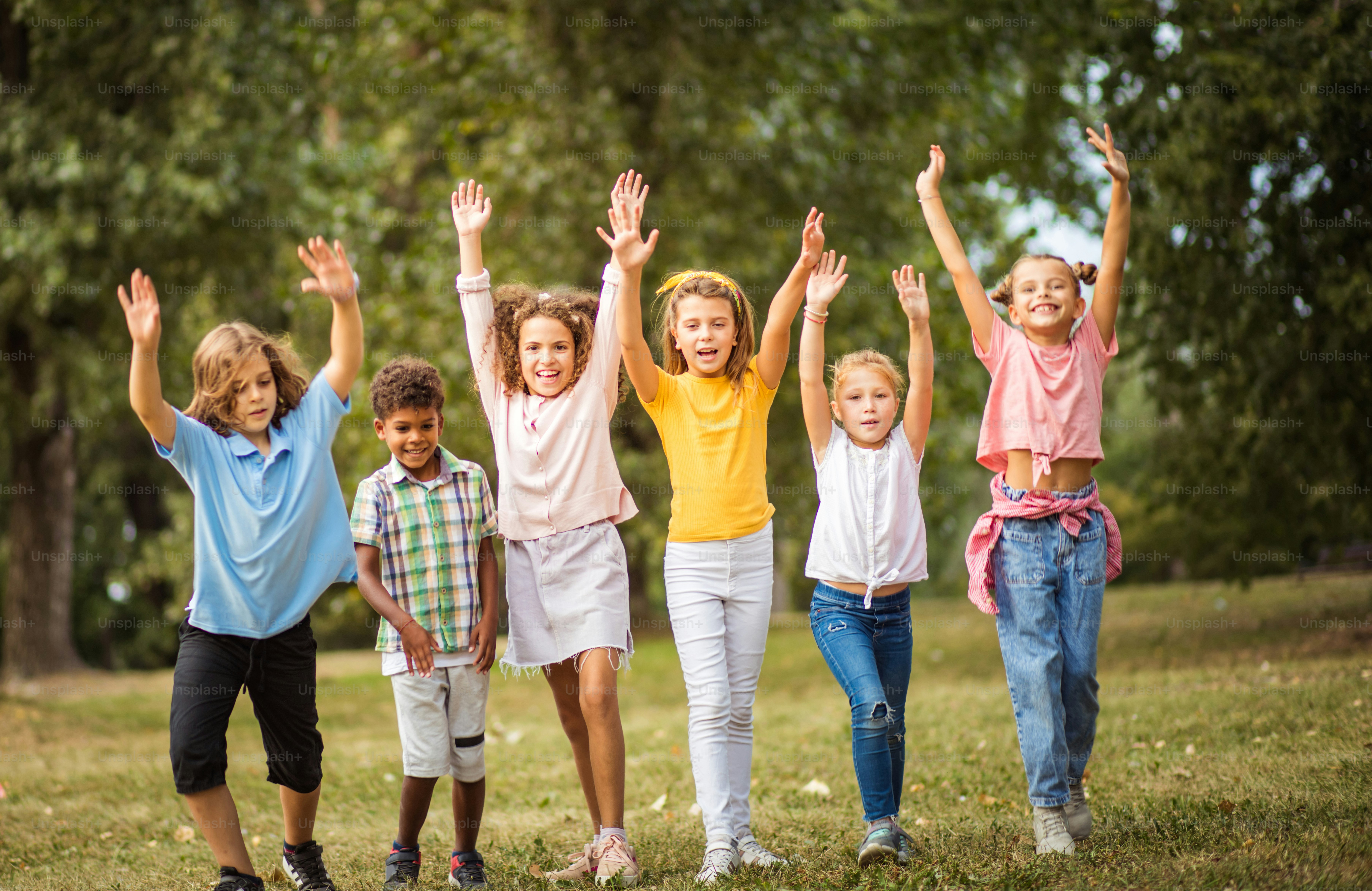 Play time in nature. Large group of school kids having fun in nature ...