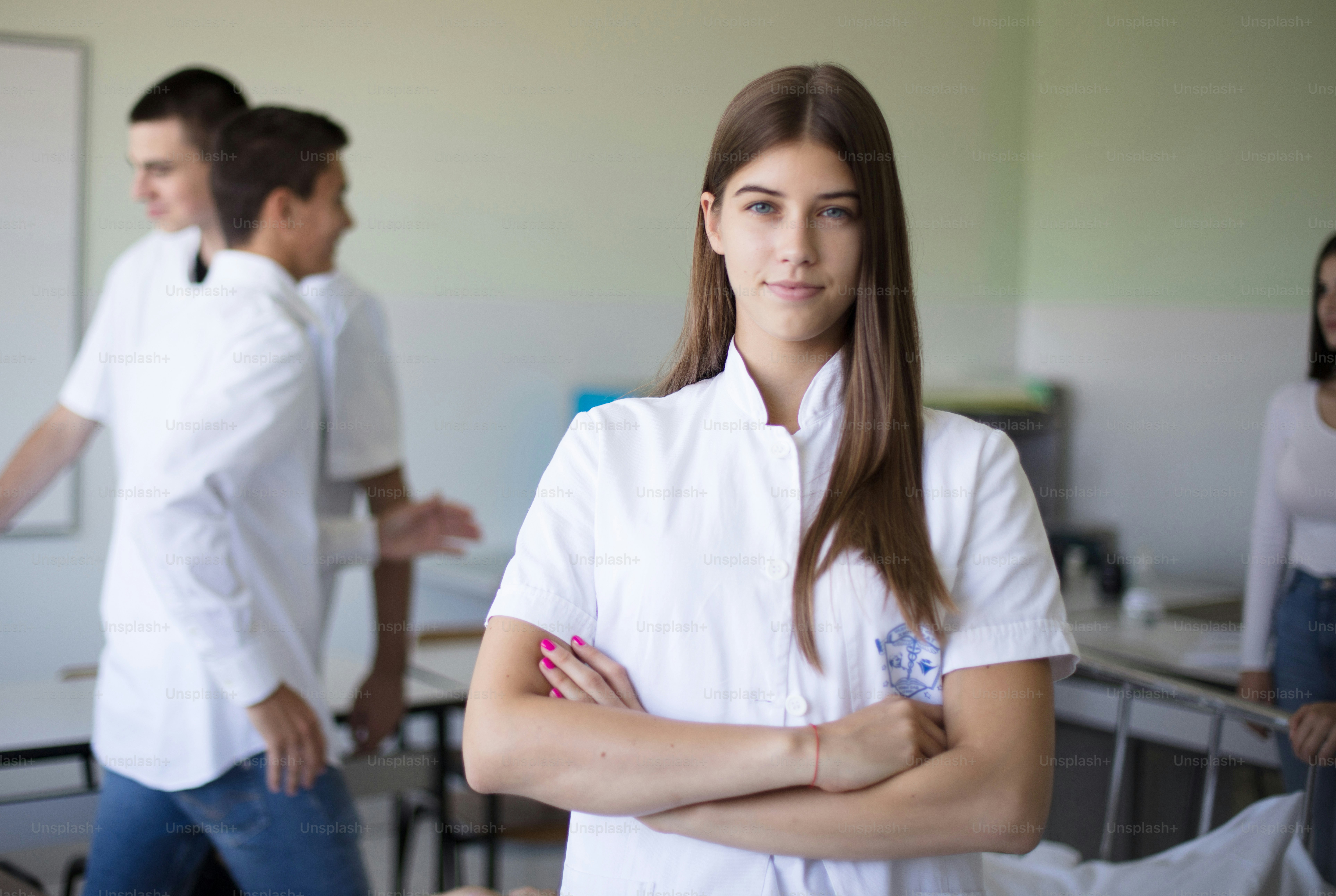 Portrait of a young medical student. Medical students in patient room ...