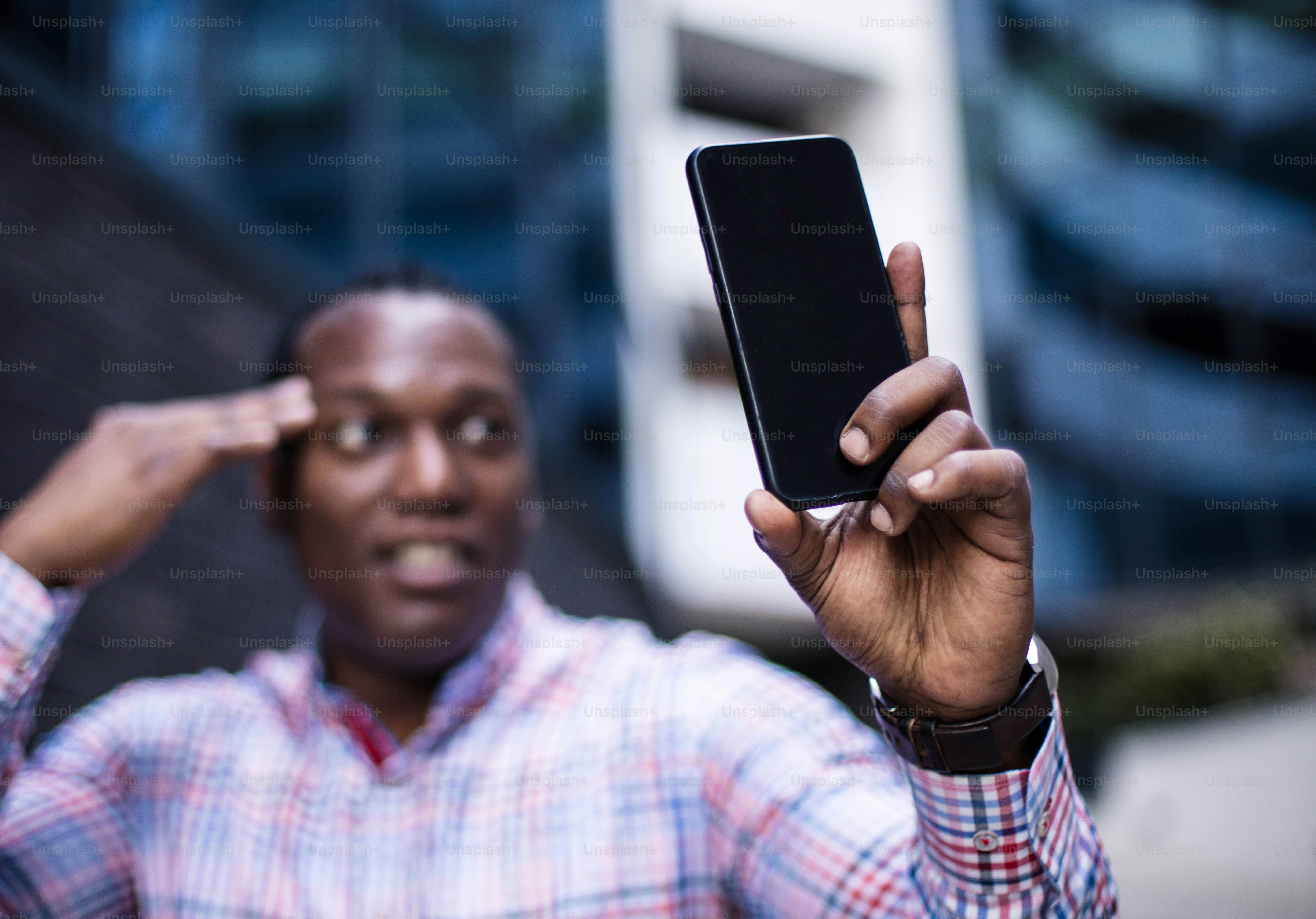 Business man outside having video call. Focus is on hand. photo – Black ...