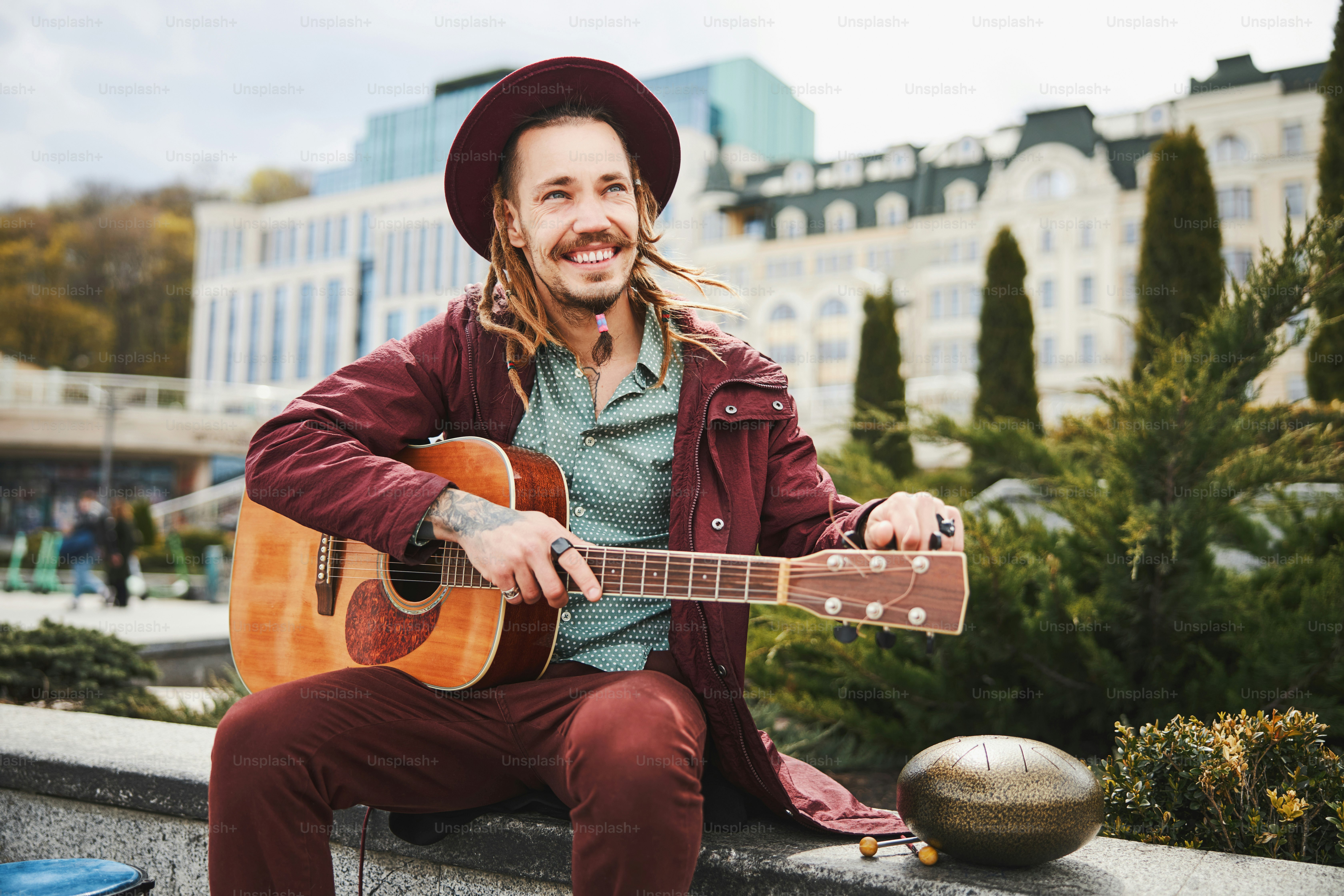 Happy male person enjoying city views while playing good music in the ...