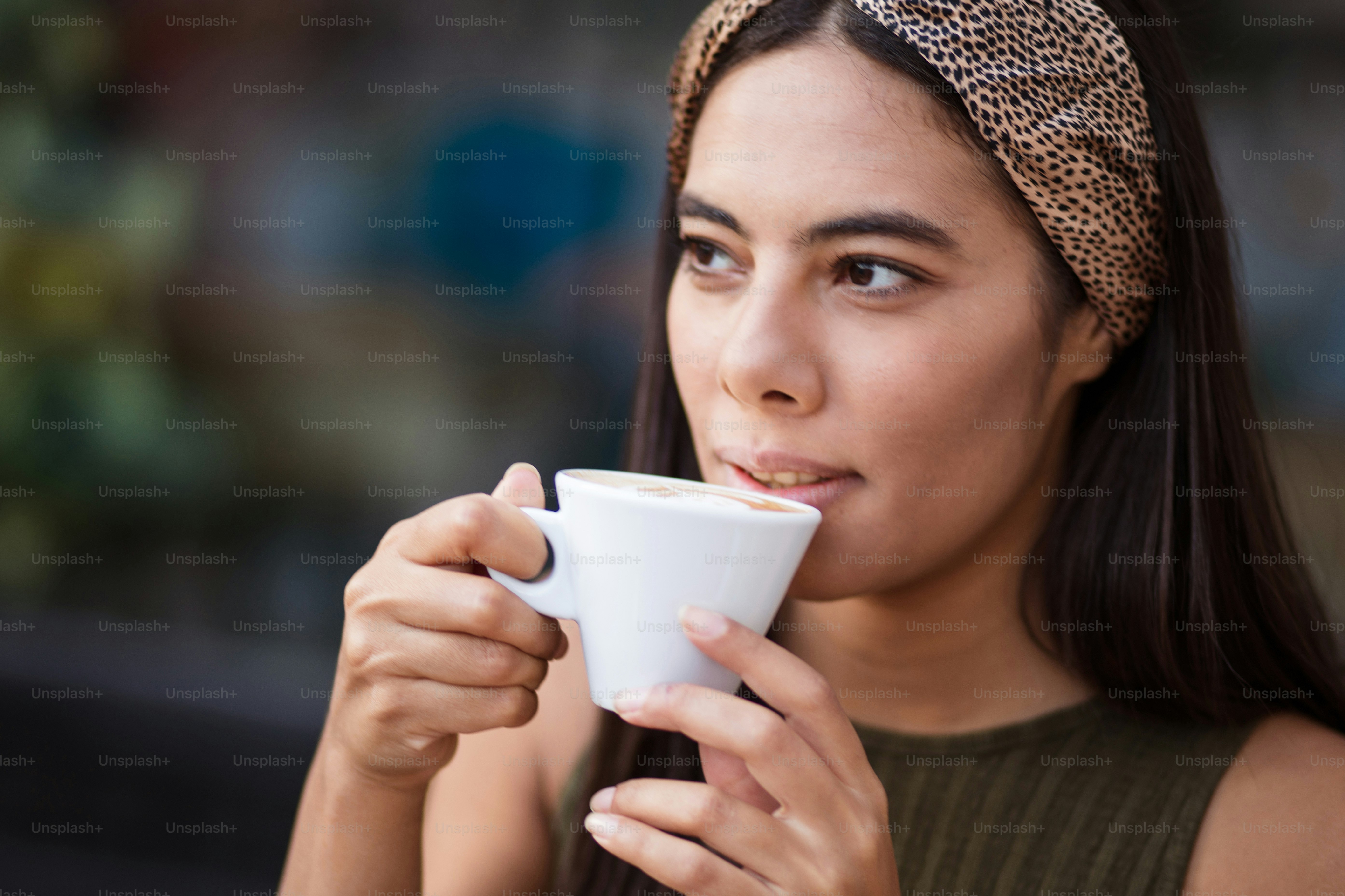 African woman holding and drinking coffee alone. photo – Three people ...