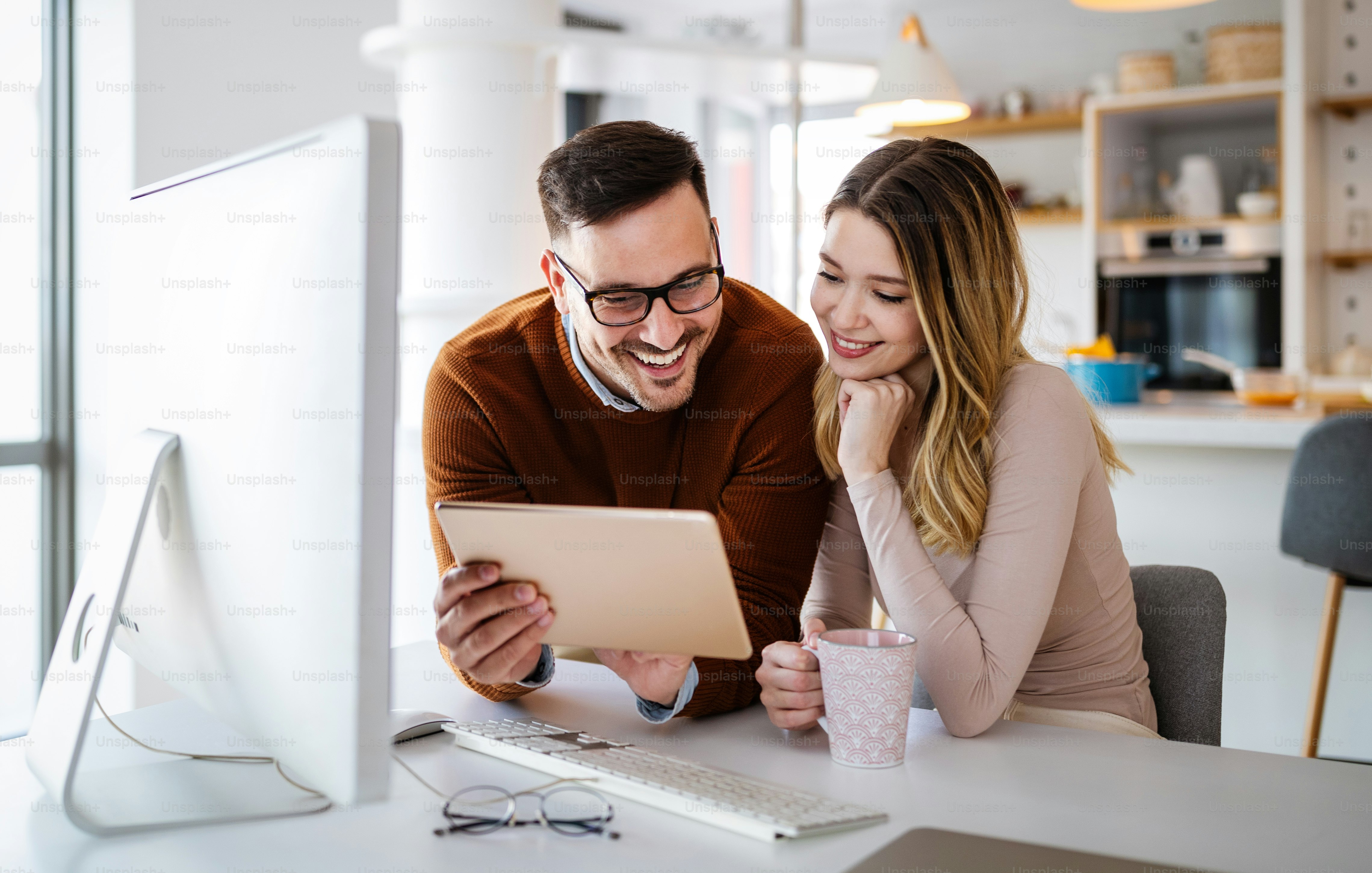 Happy successful business partners working at meeting in office ...