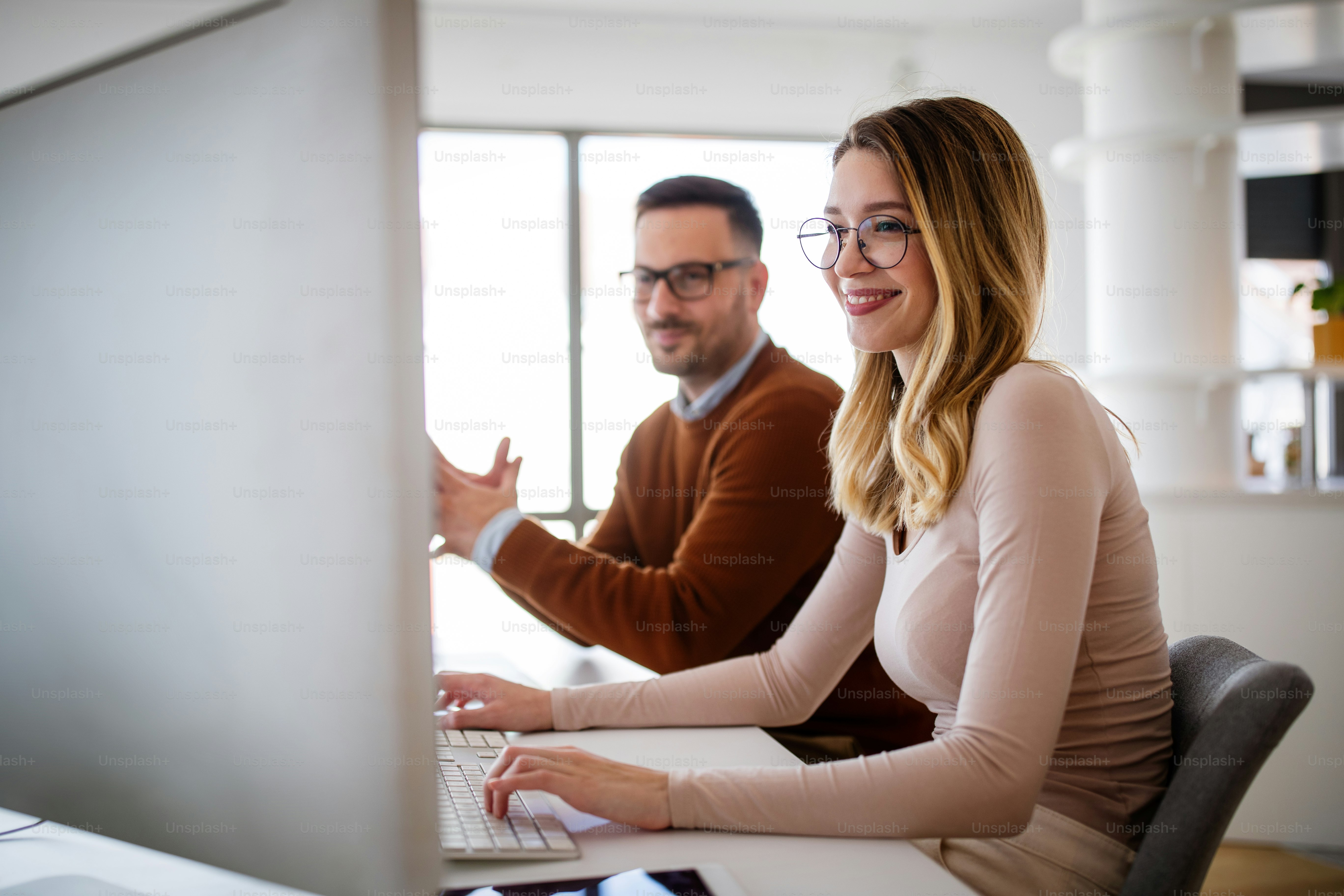 Happy successful business partners working at meeting in office ...