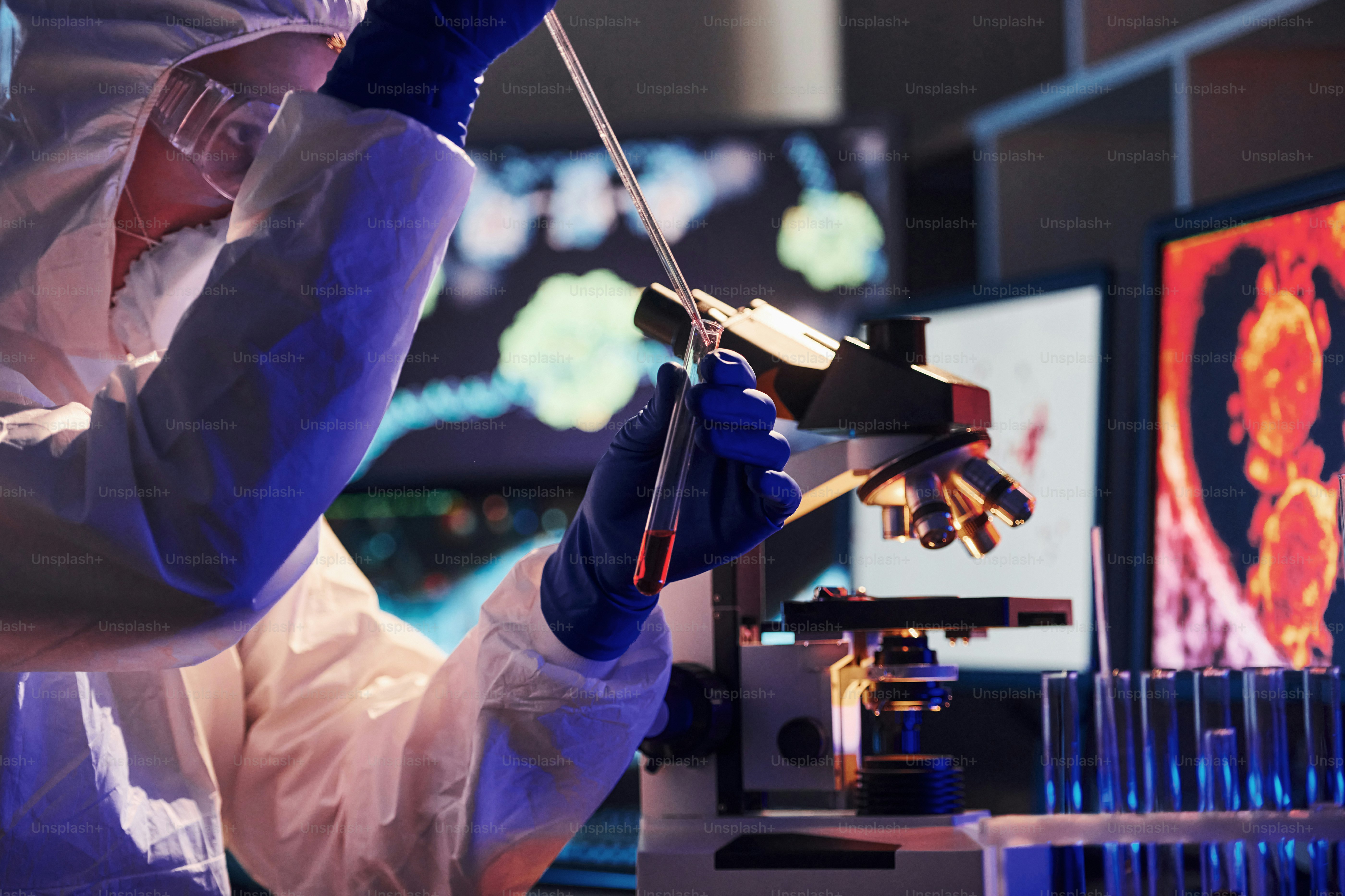 Scientist in white protective uniform works with coronavirus and blood ...