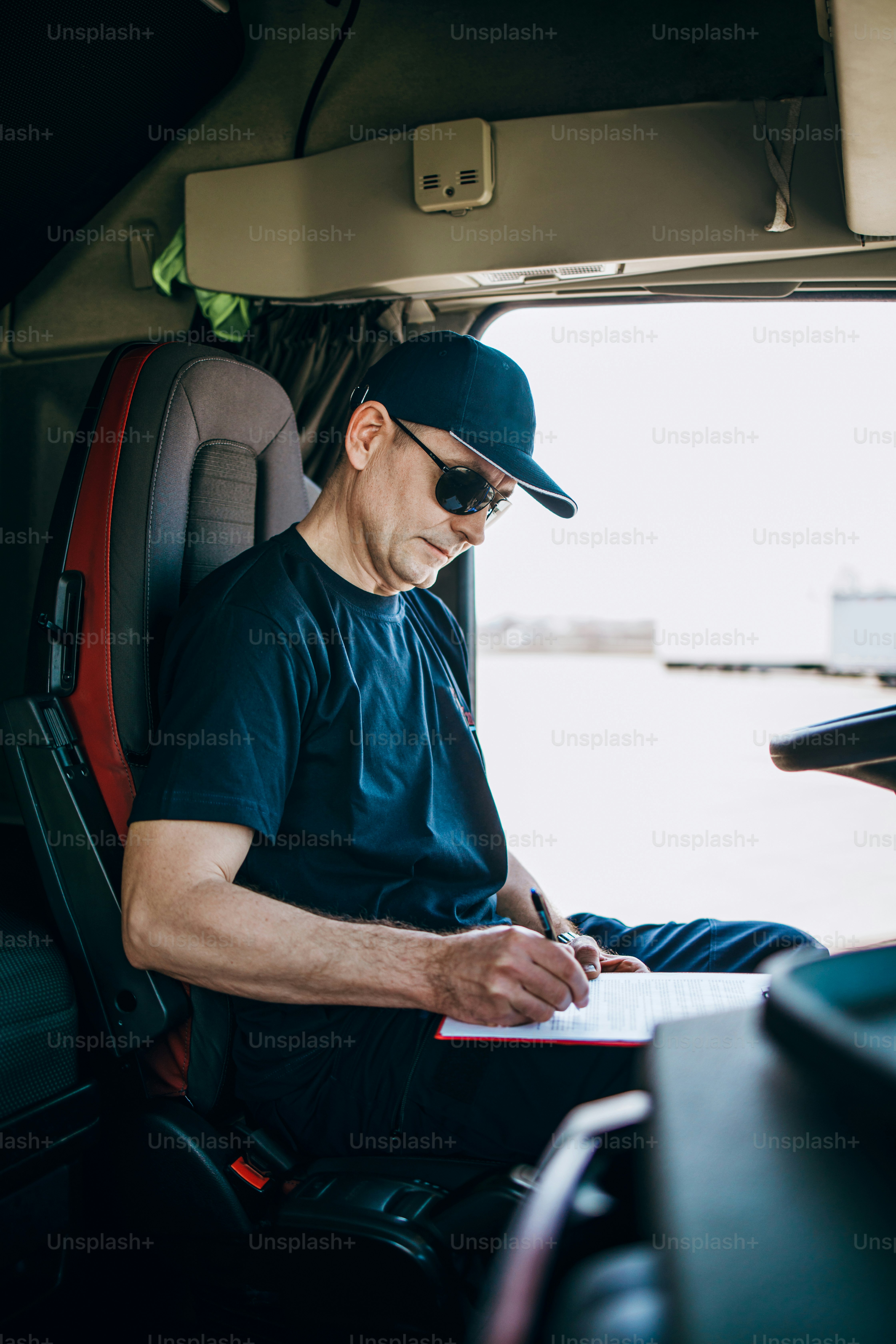Experienced truck driver sitting in his truck and waiting for a new ...