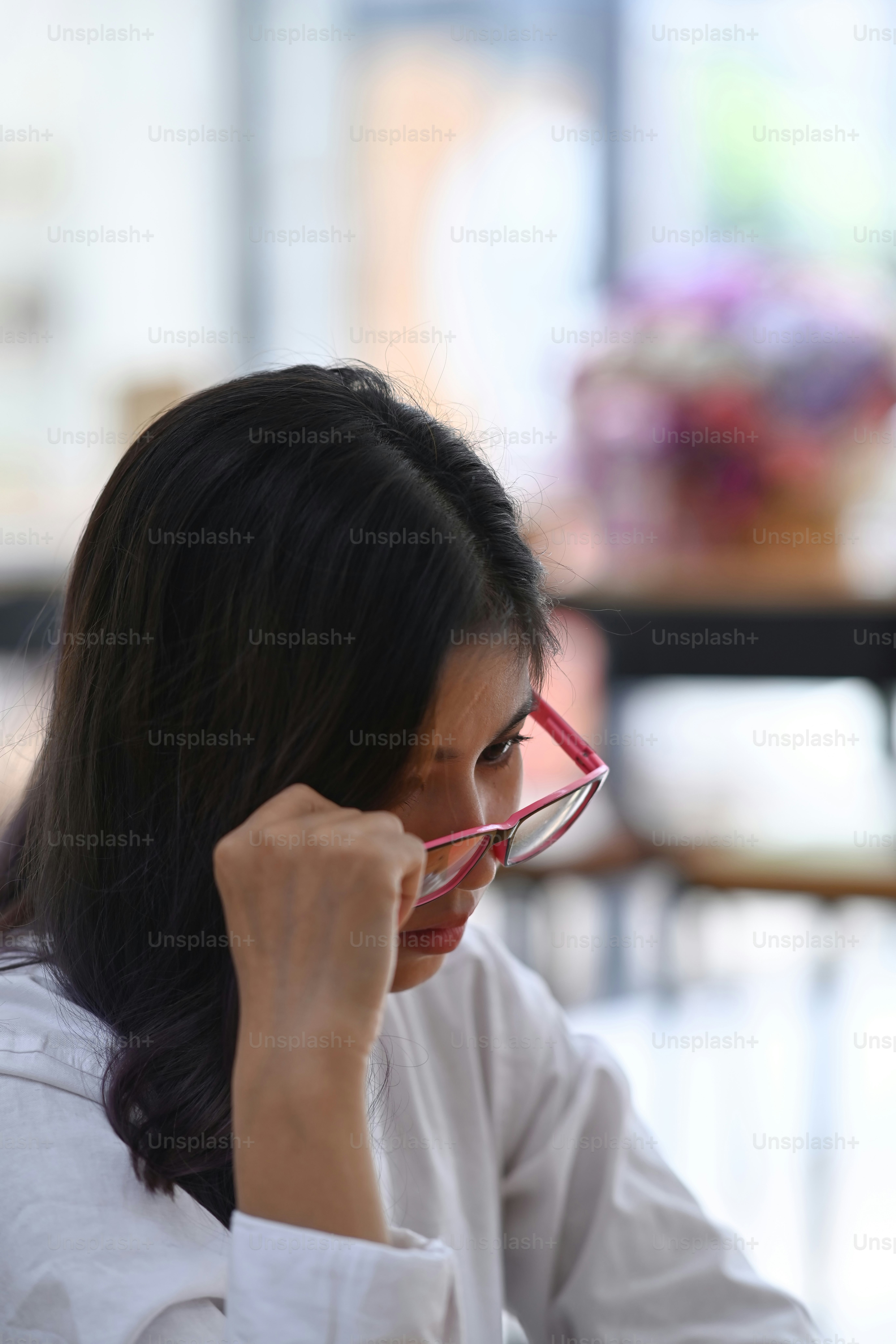 Stressed female office worker holding glasses feeling eye strain ...