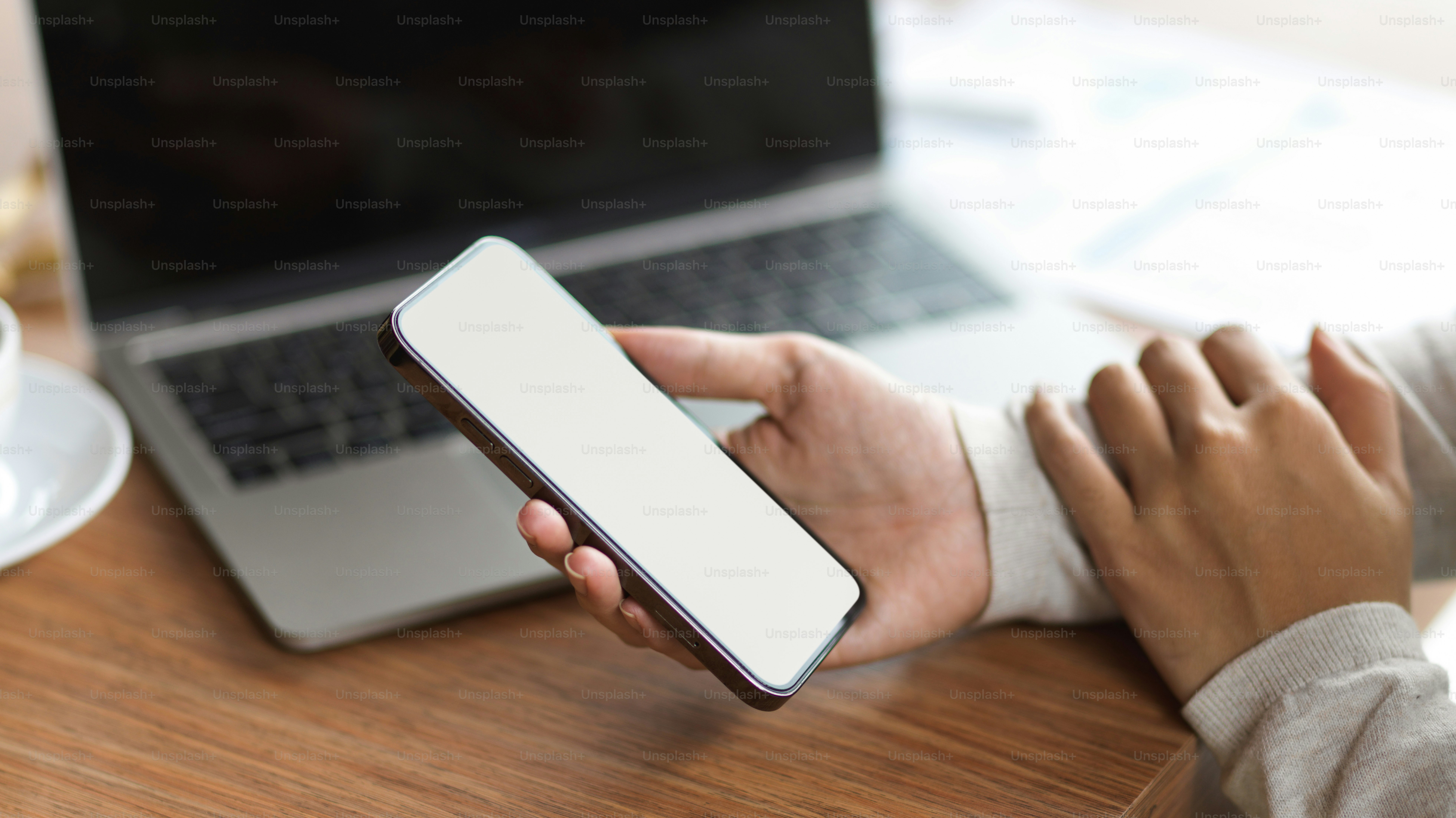 Cropped shot of businessman holding mobile phone with blank screen on ...