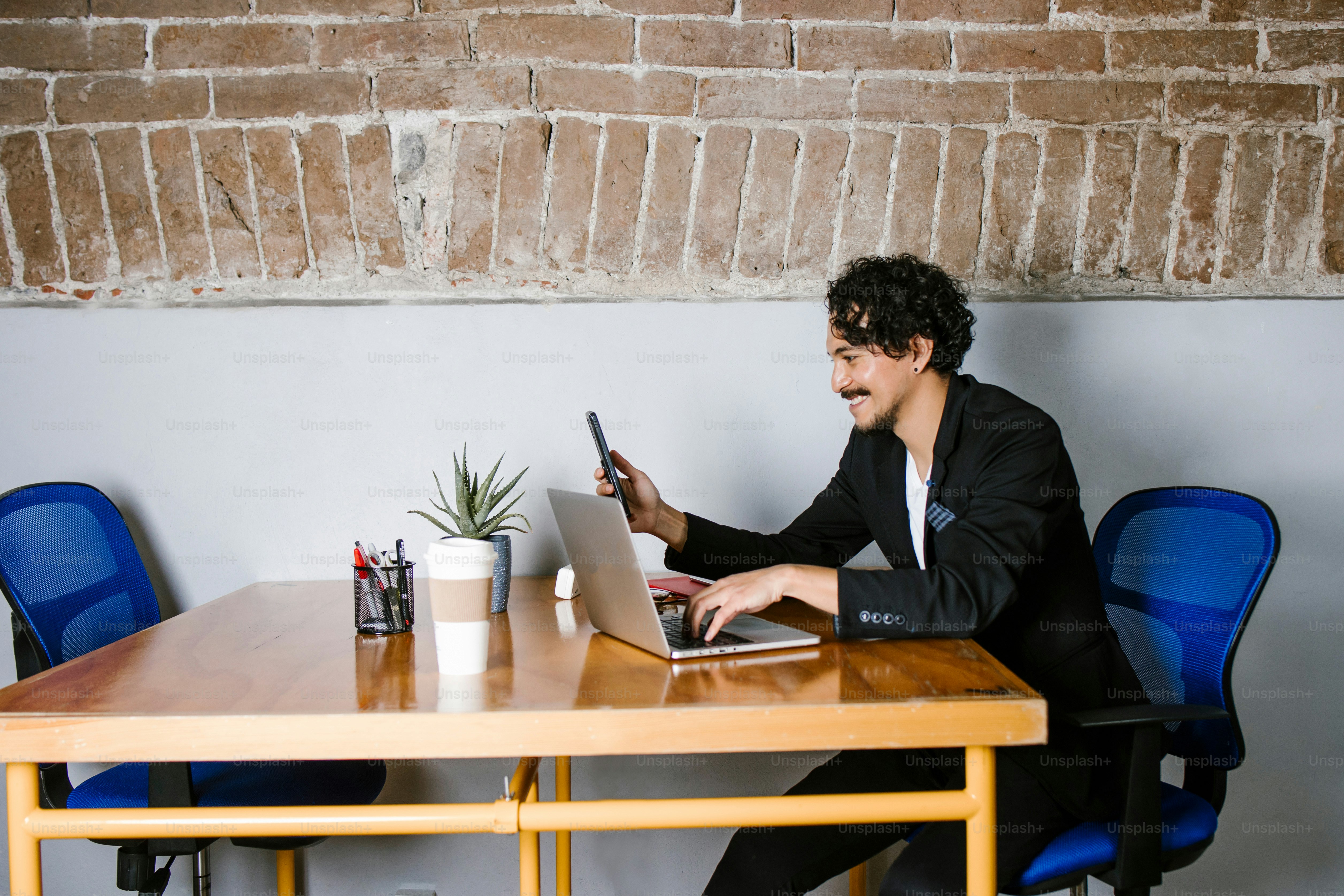 Latin man working with computer at office in Mexico city photo ...