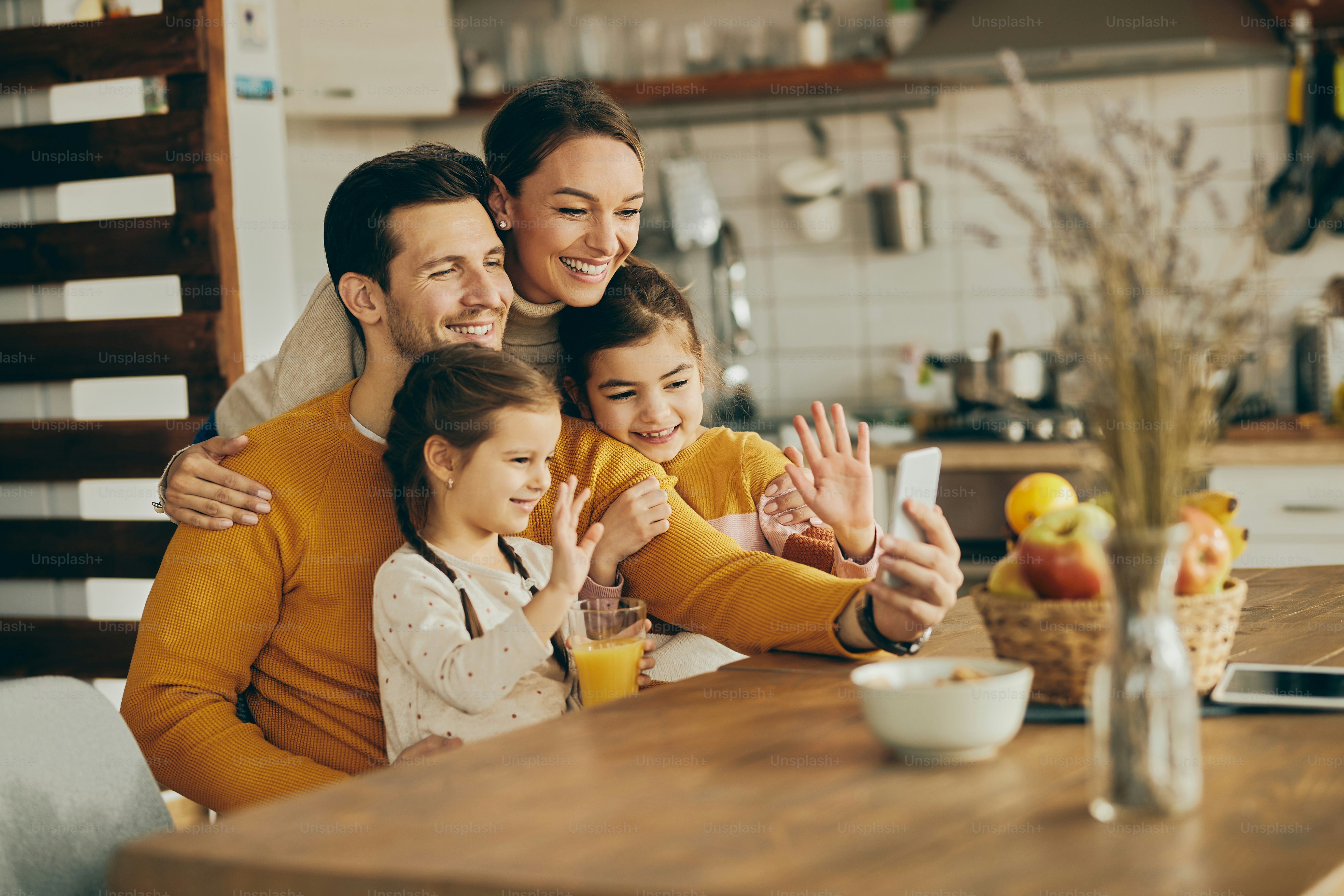 Happy parents with kids taking selfie with cell phone and having fun at ...