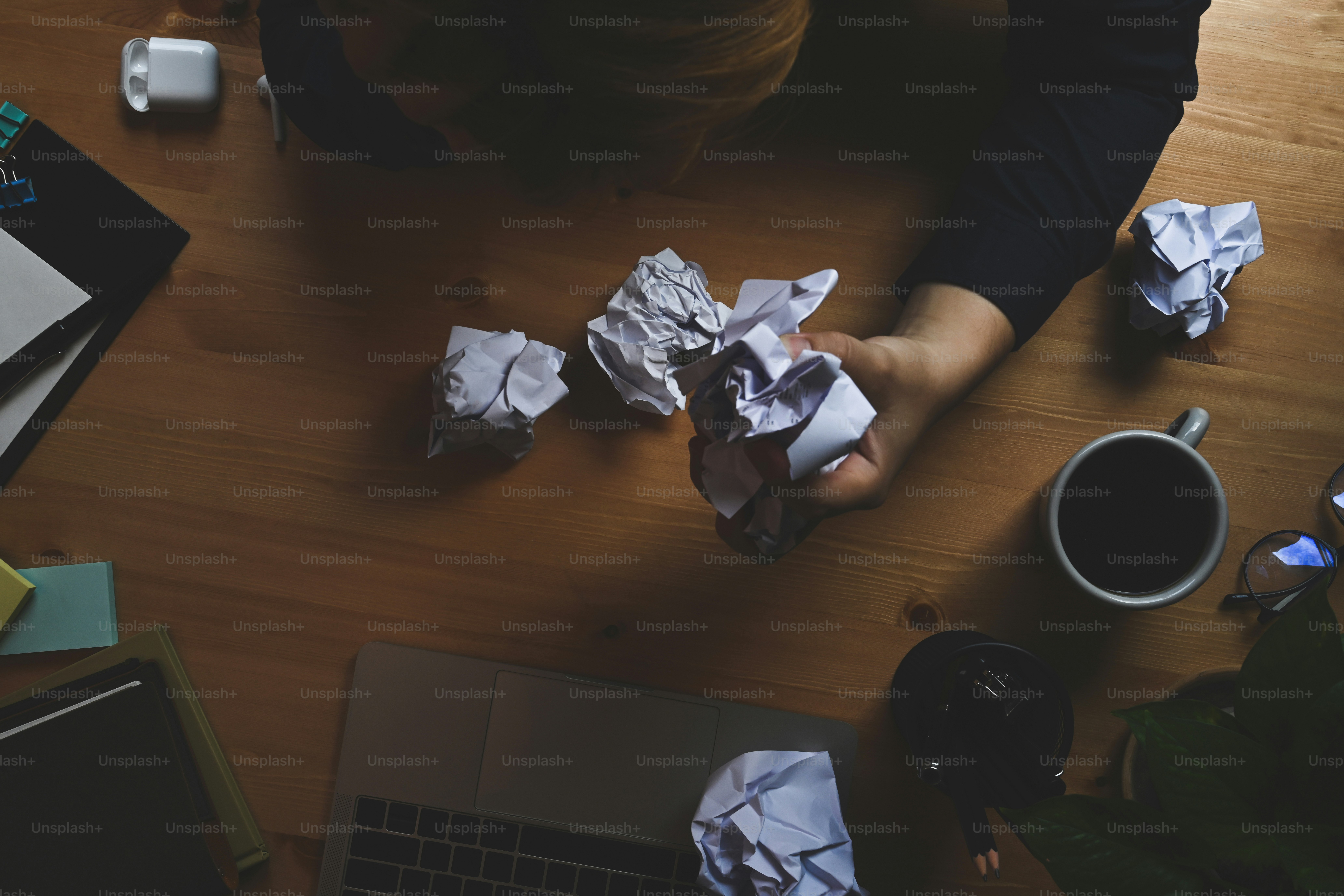 Above view stressed businessman crumpling paper at his table. photo ...