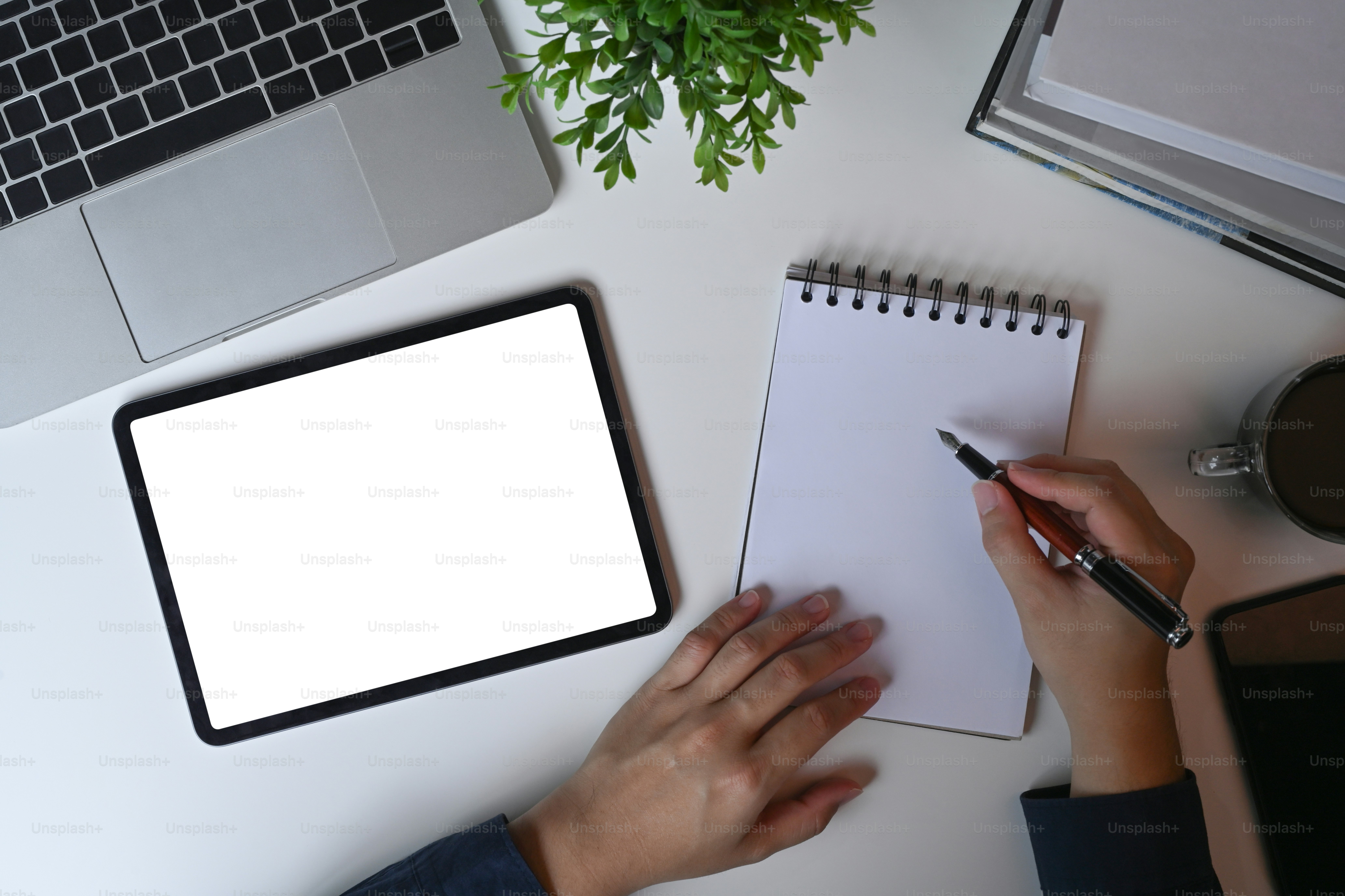 Above view man making note on notepad and using digit tablet. photo ...