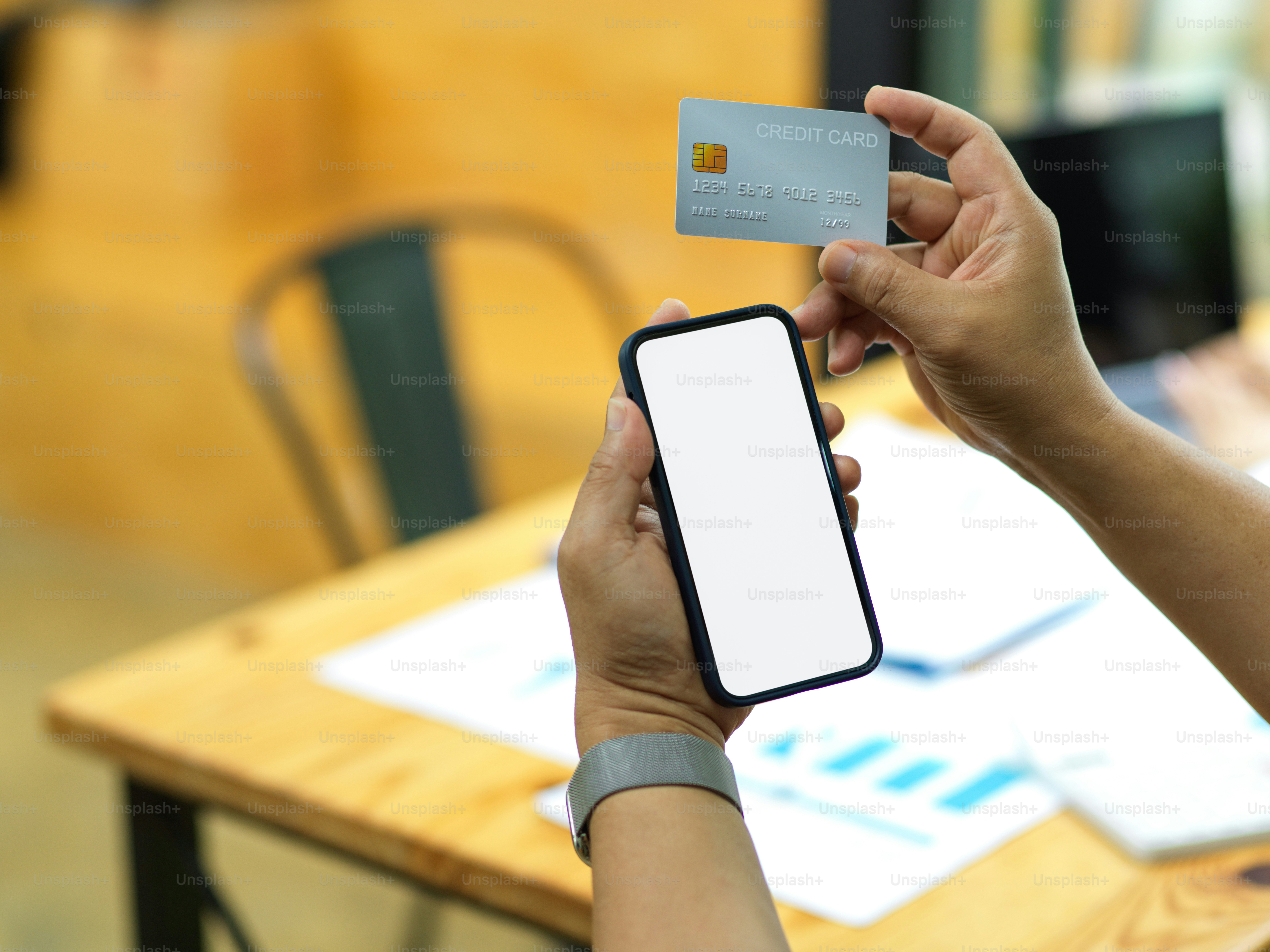 Male hands hold mobile phone and credit card, online transfer money ...