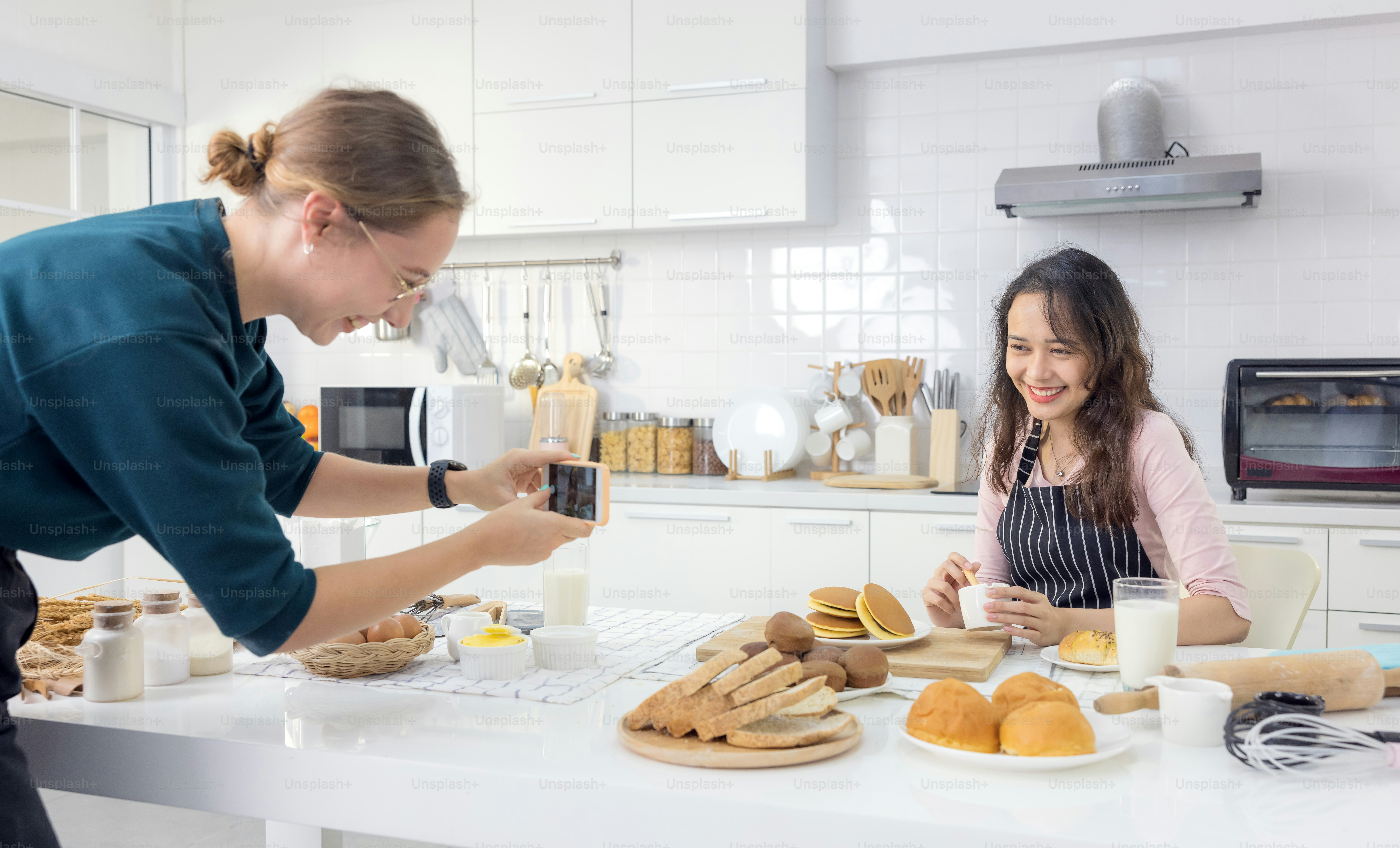 Beautiful woman pastry chef kneading bread dough on the worktop, as ...