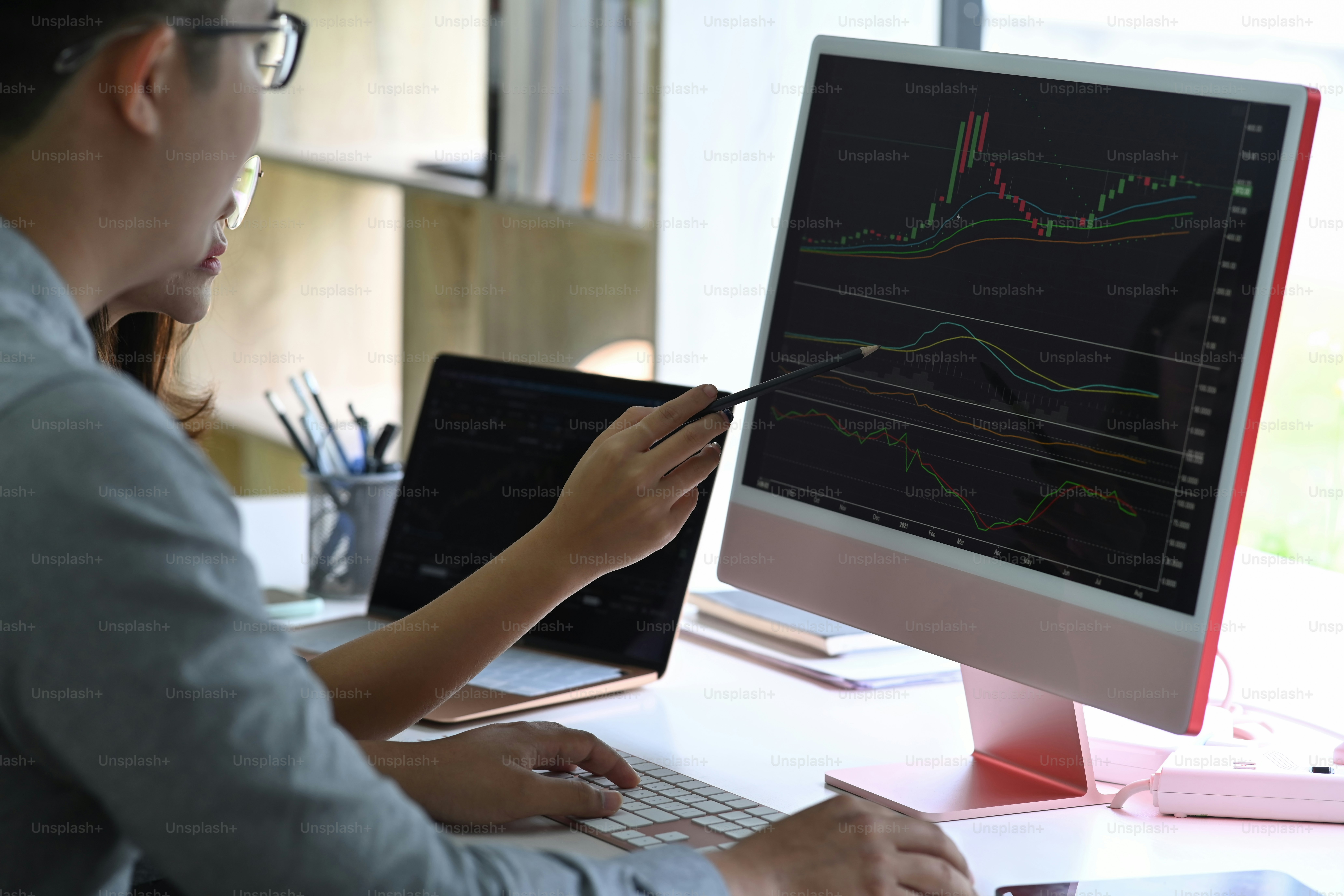 Businesspeople analyzing finance data graphs on screen of computer ...