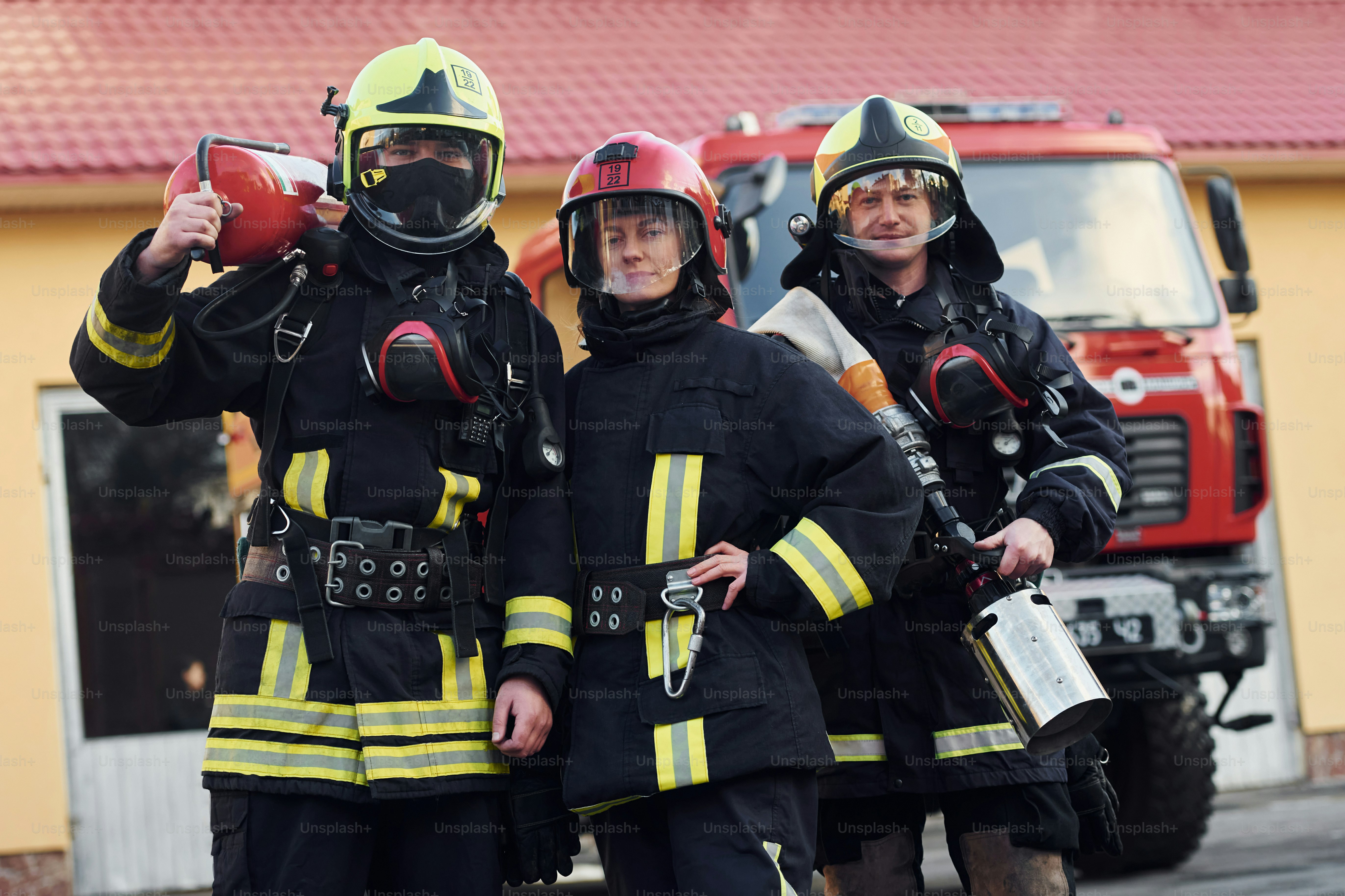 Group of firefighters in protective uniform that outdoors near truck ...