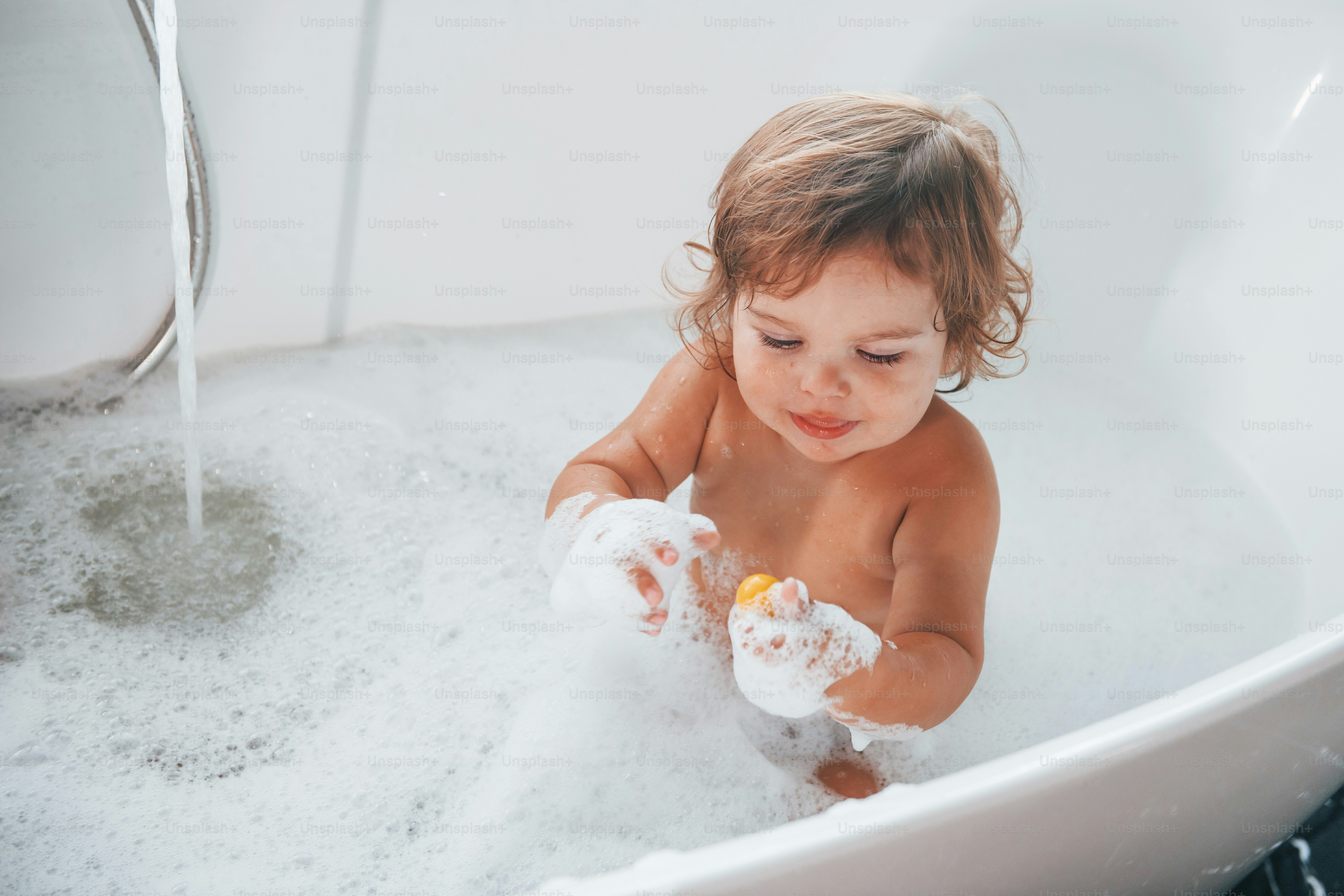 Cute little girl washing in the bat at home. Top view. photo – Cute ...