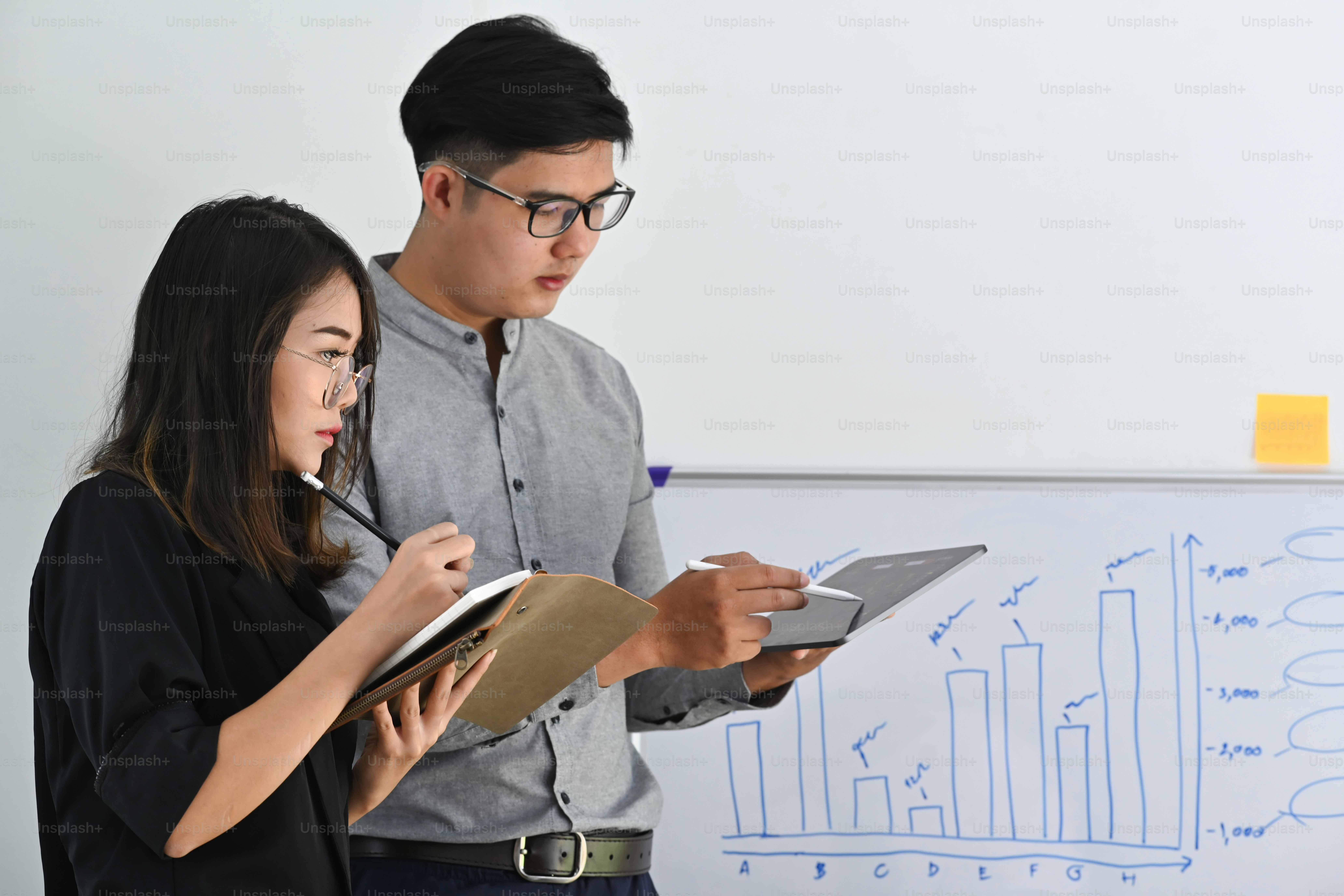 Two business people talking project strategy at modern office. photo ...