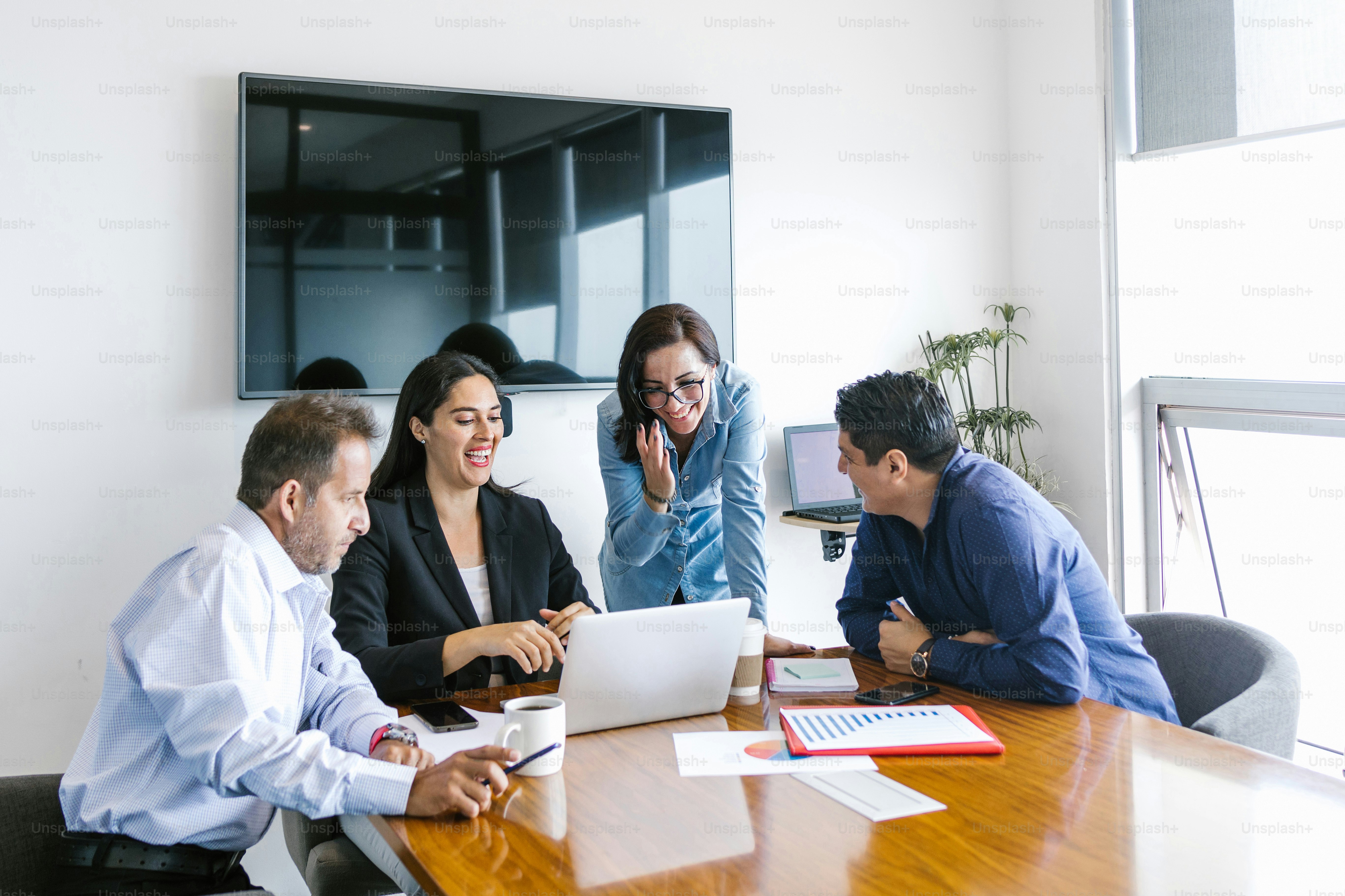 Group of hispanic people doing teamwork in office using digital devices ...