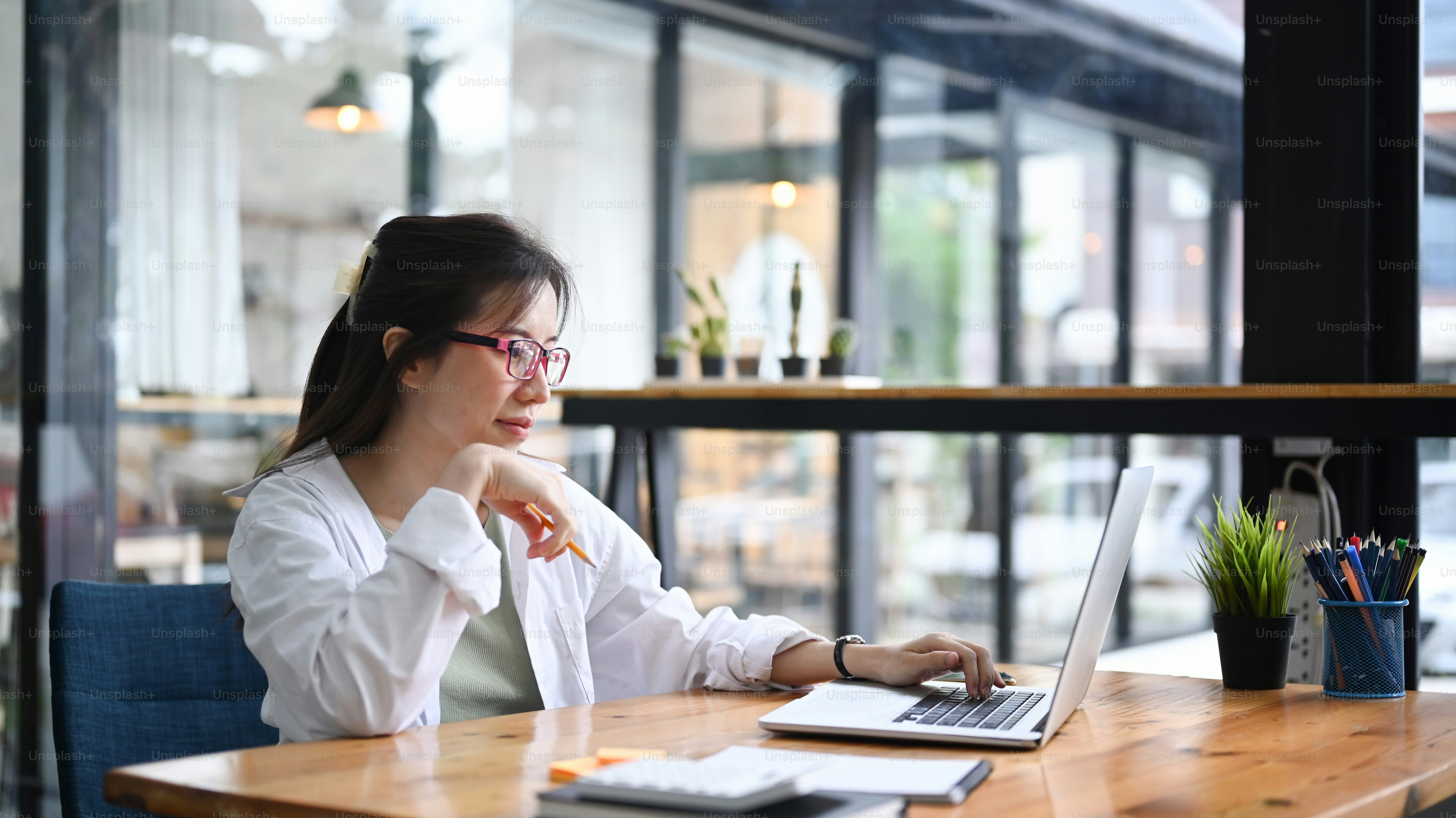 Female entrepreneur working with laptop computer at modern workplace ...