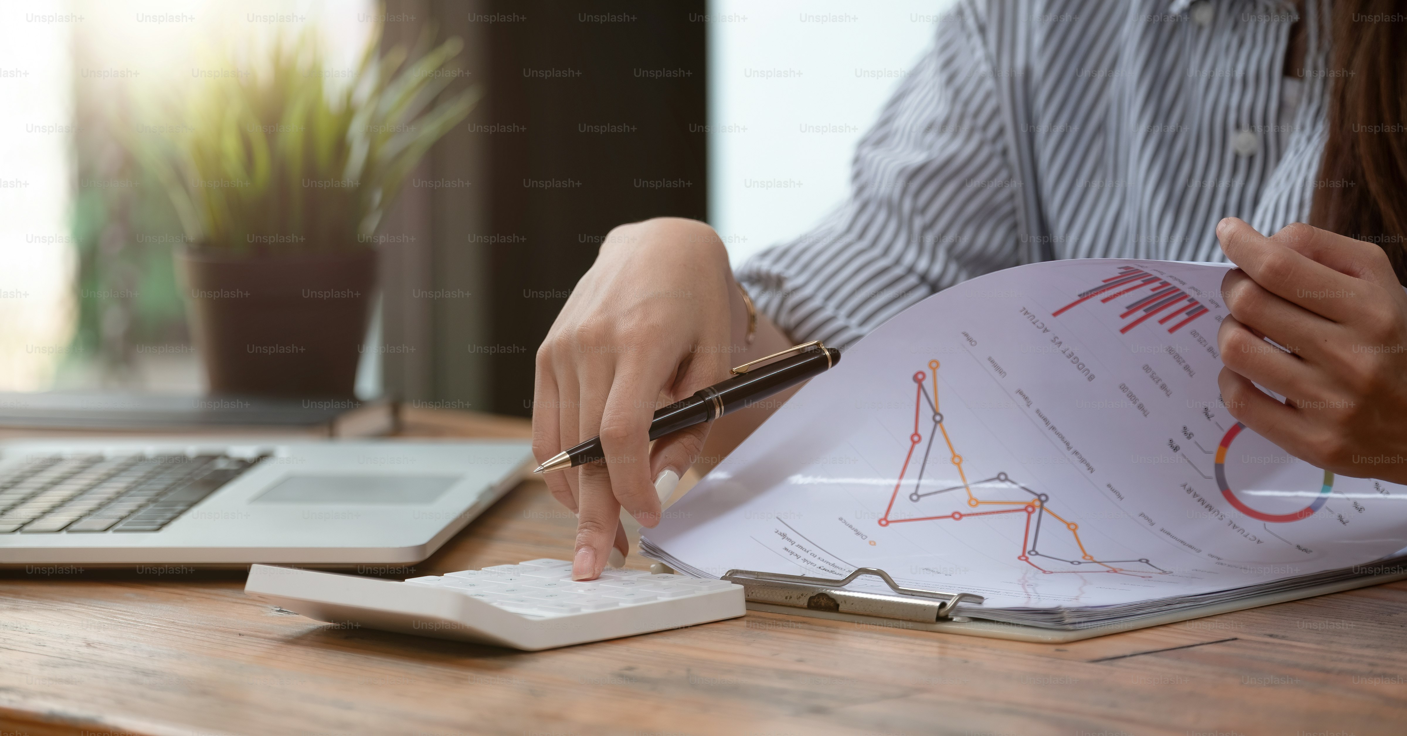 Businesswoman or accountant Analyzing Graph And Using Calculator ...