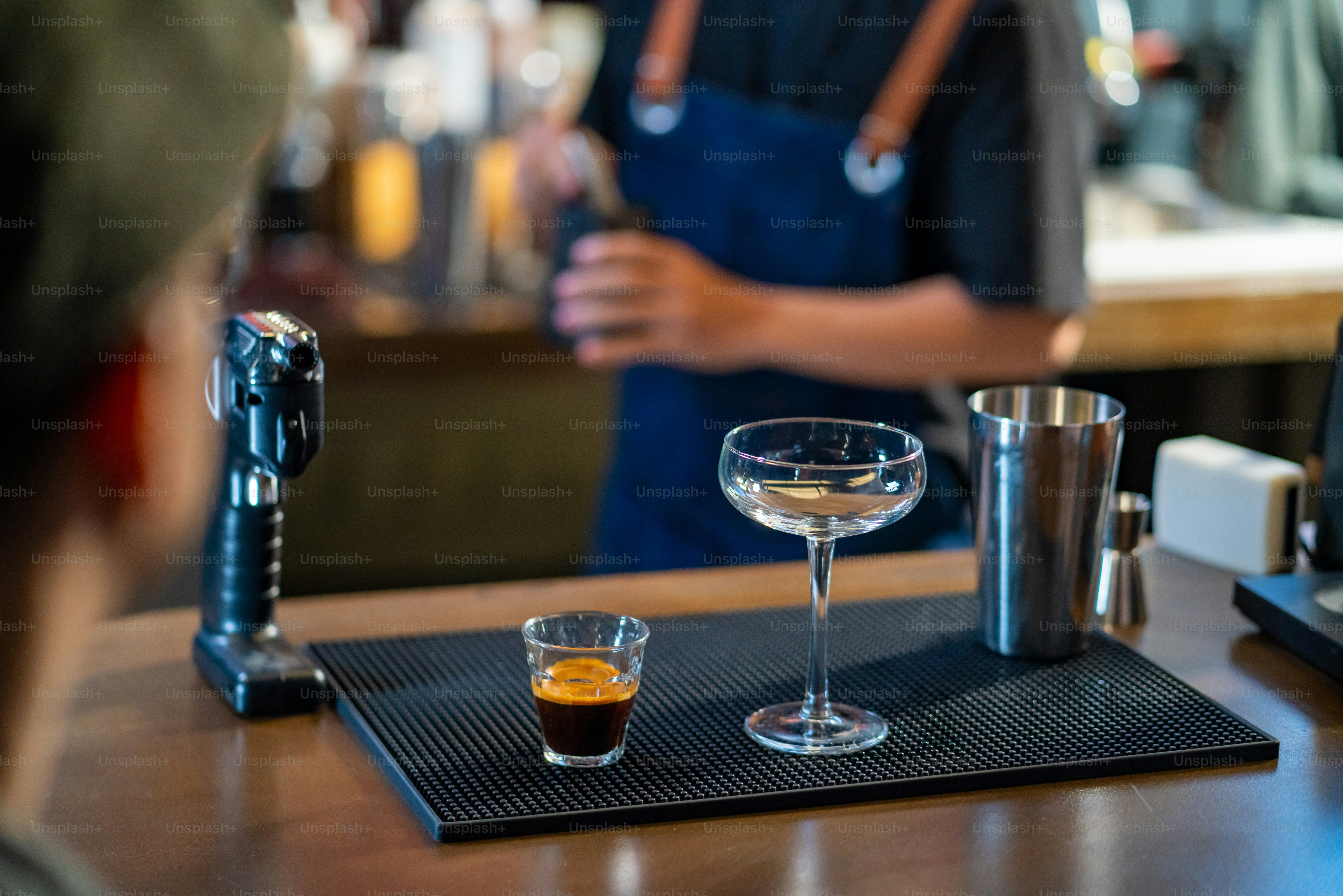 Asian man barista shaking iced black coffee in shaker and pouring in ...