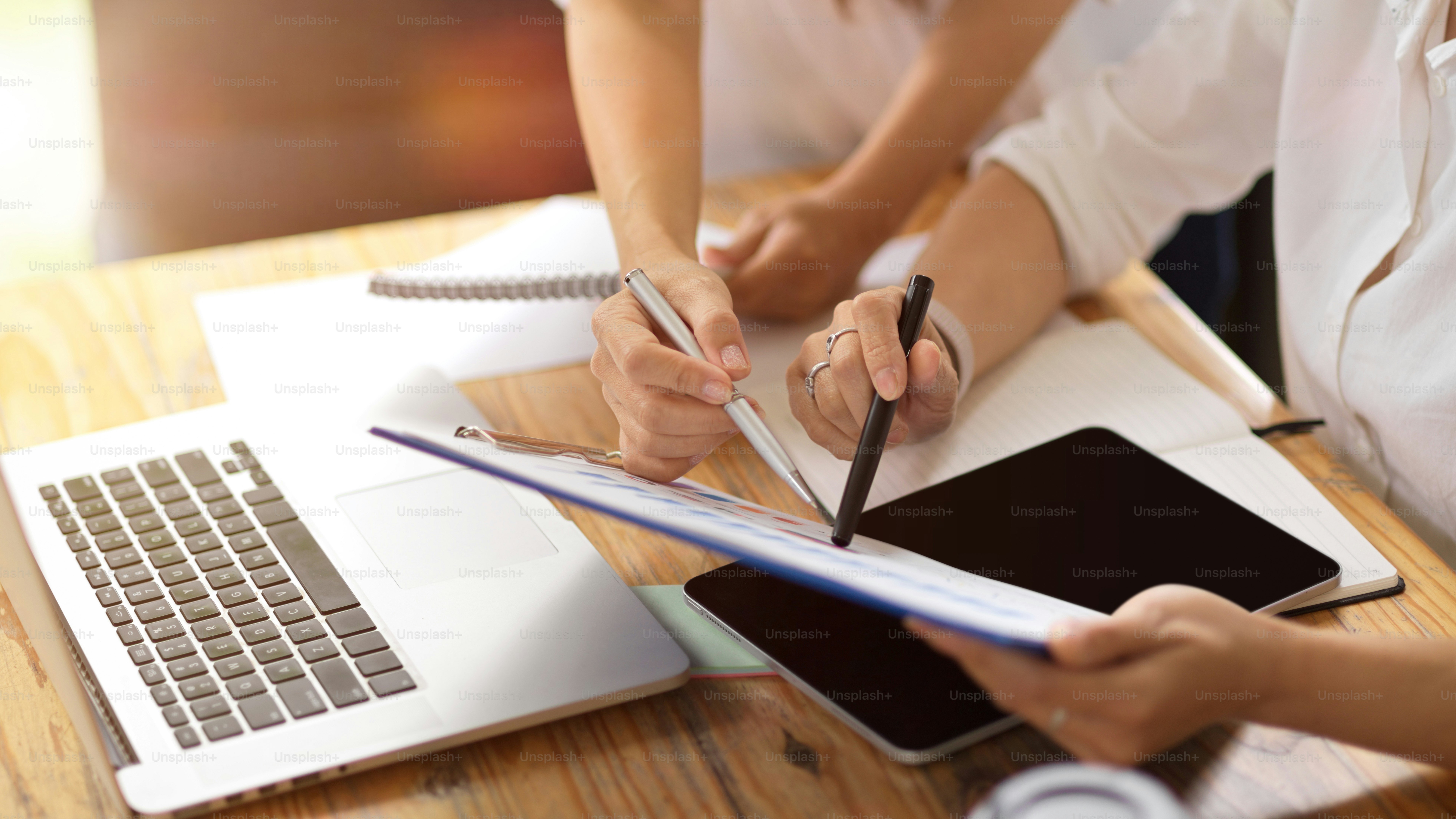 Two women analysing document while meeting in office, explaining ...