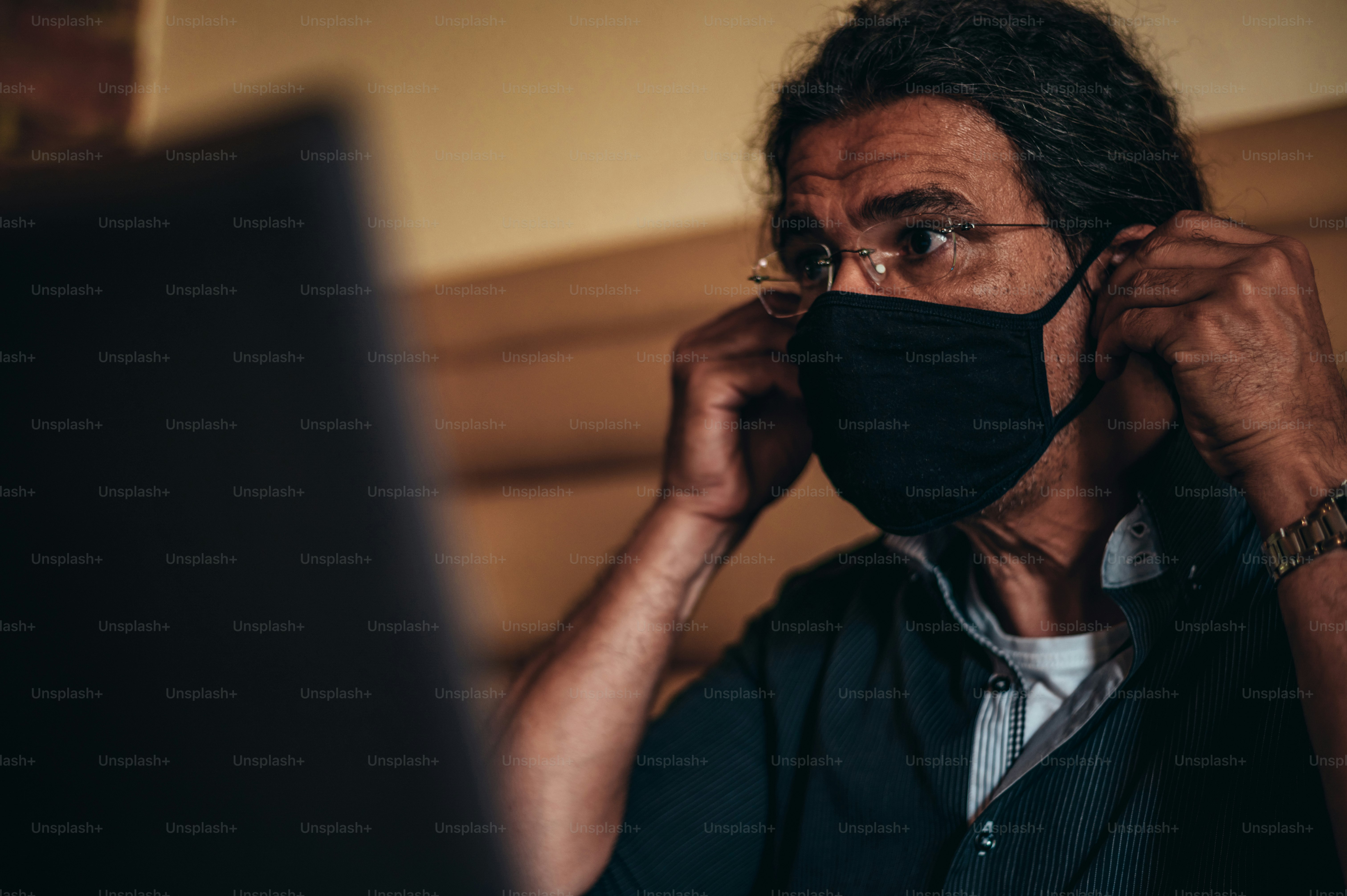 Senior hispanic cuban men putting on a protective face mask while ...