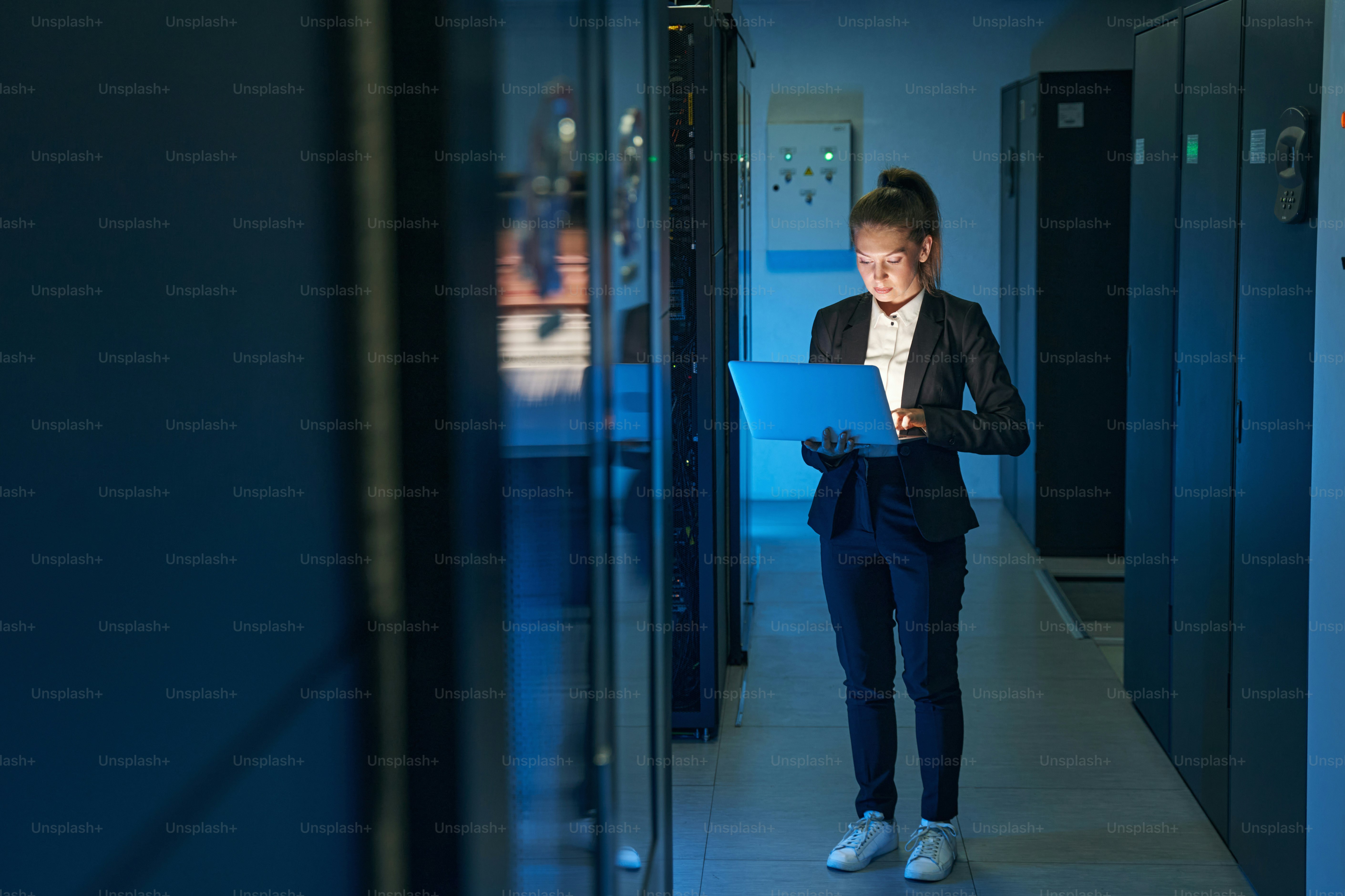 Young woman IT engineer use laptop computer while working with ...