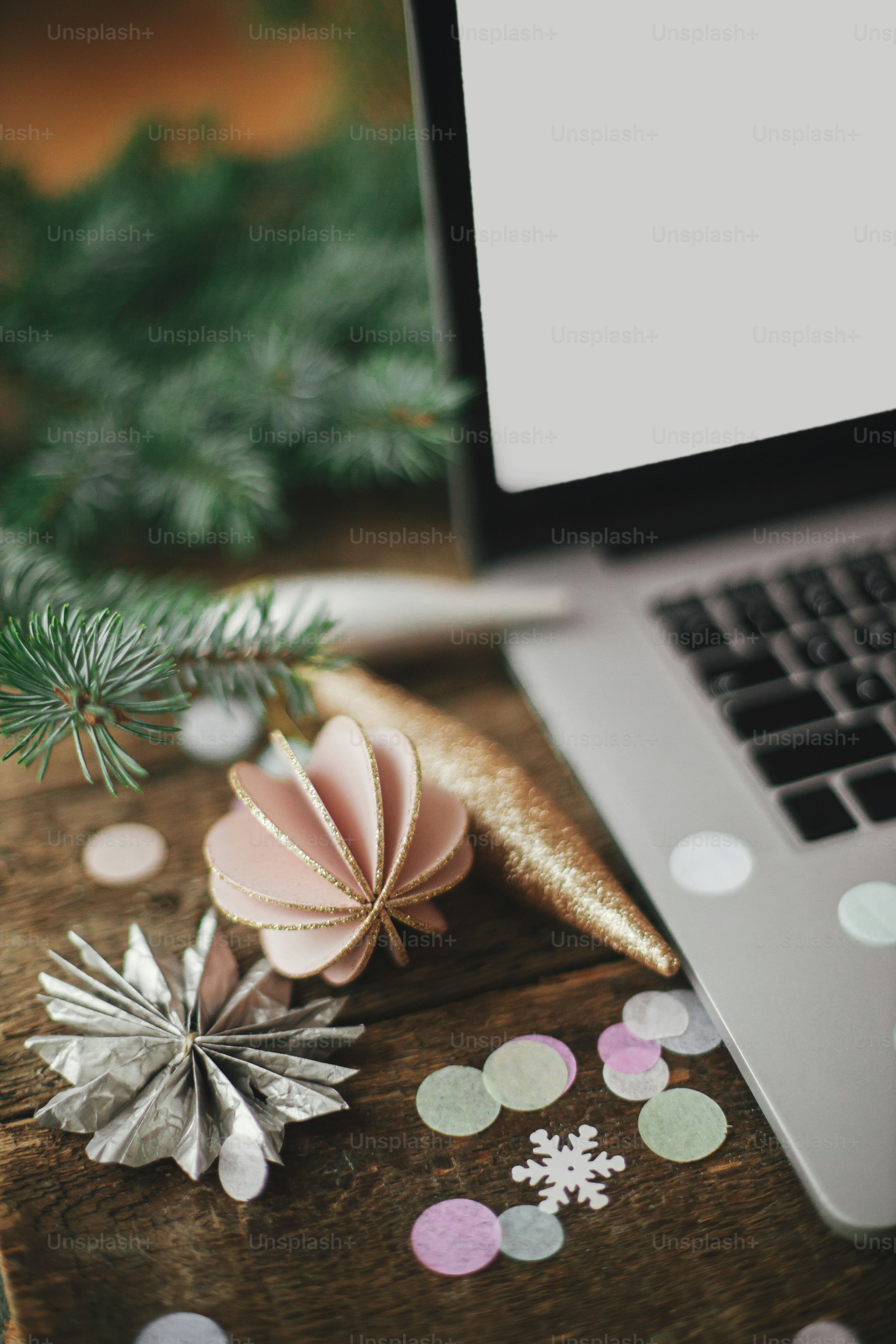 Stylish christmas ornaments and decorations on background of laptop ...