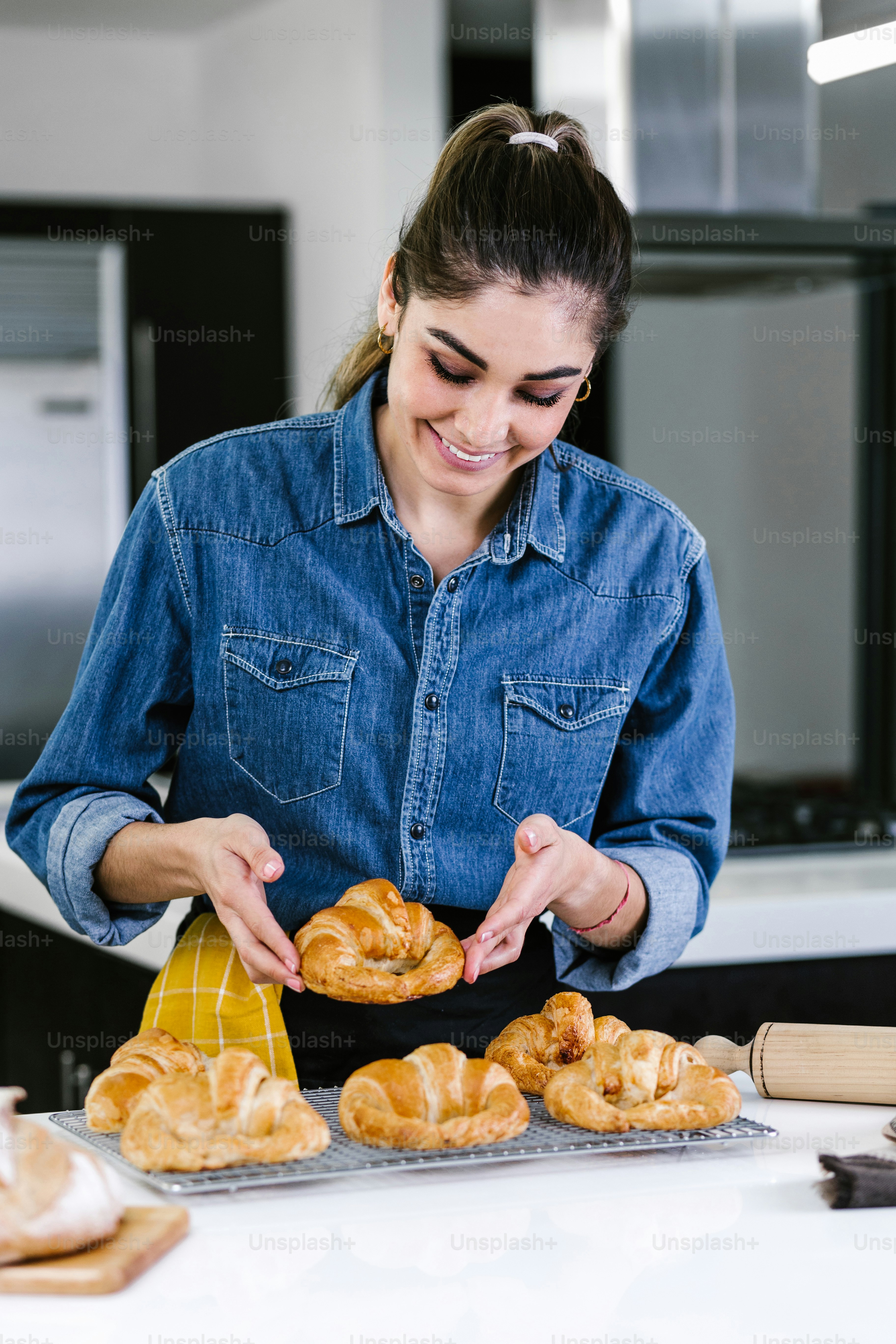 Young Latin woman baking croissant ingredients in kitchen in Mexico ...