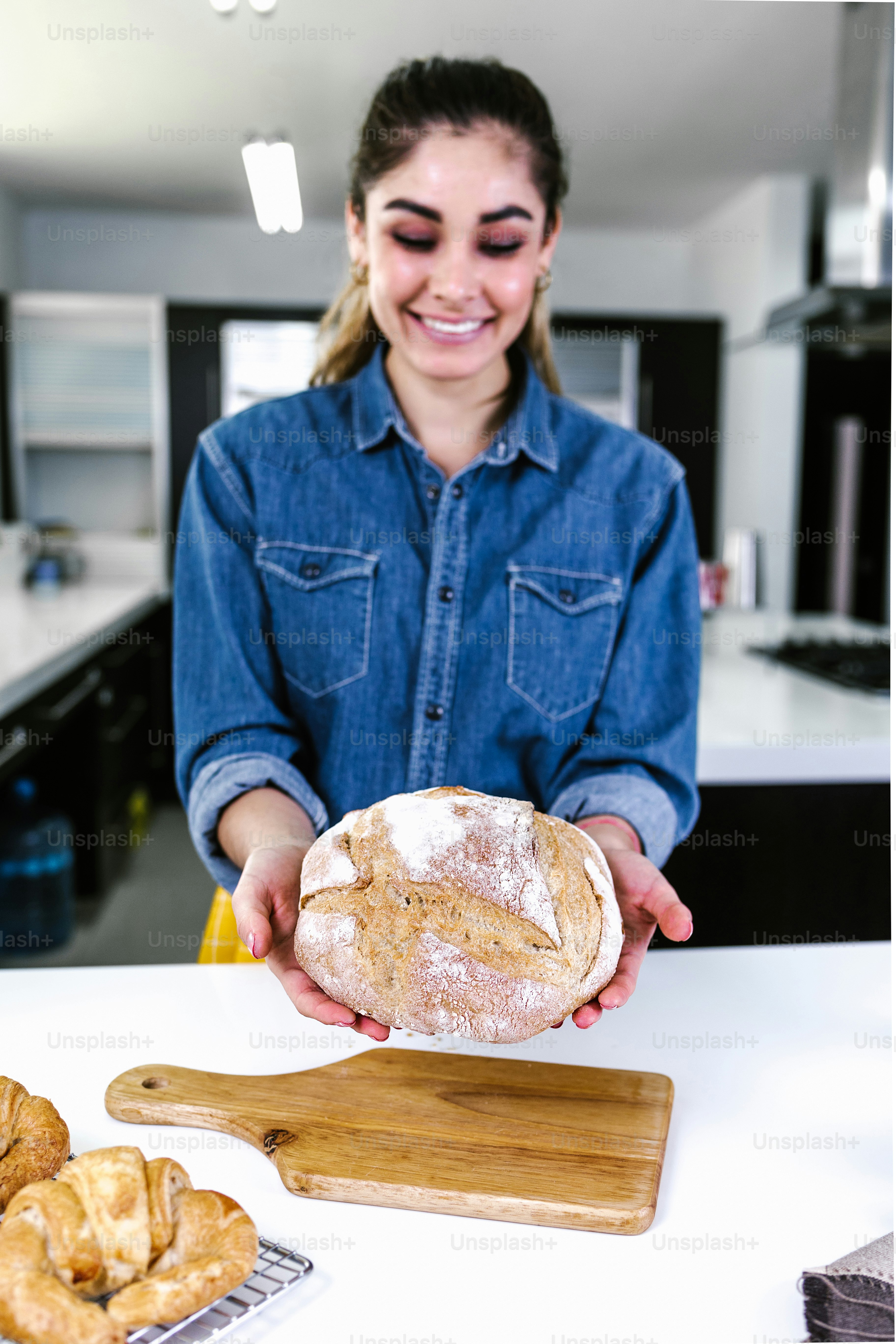 Young Latin woman baking croissant ingredients in kitchen in Mexico ...