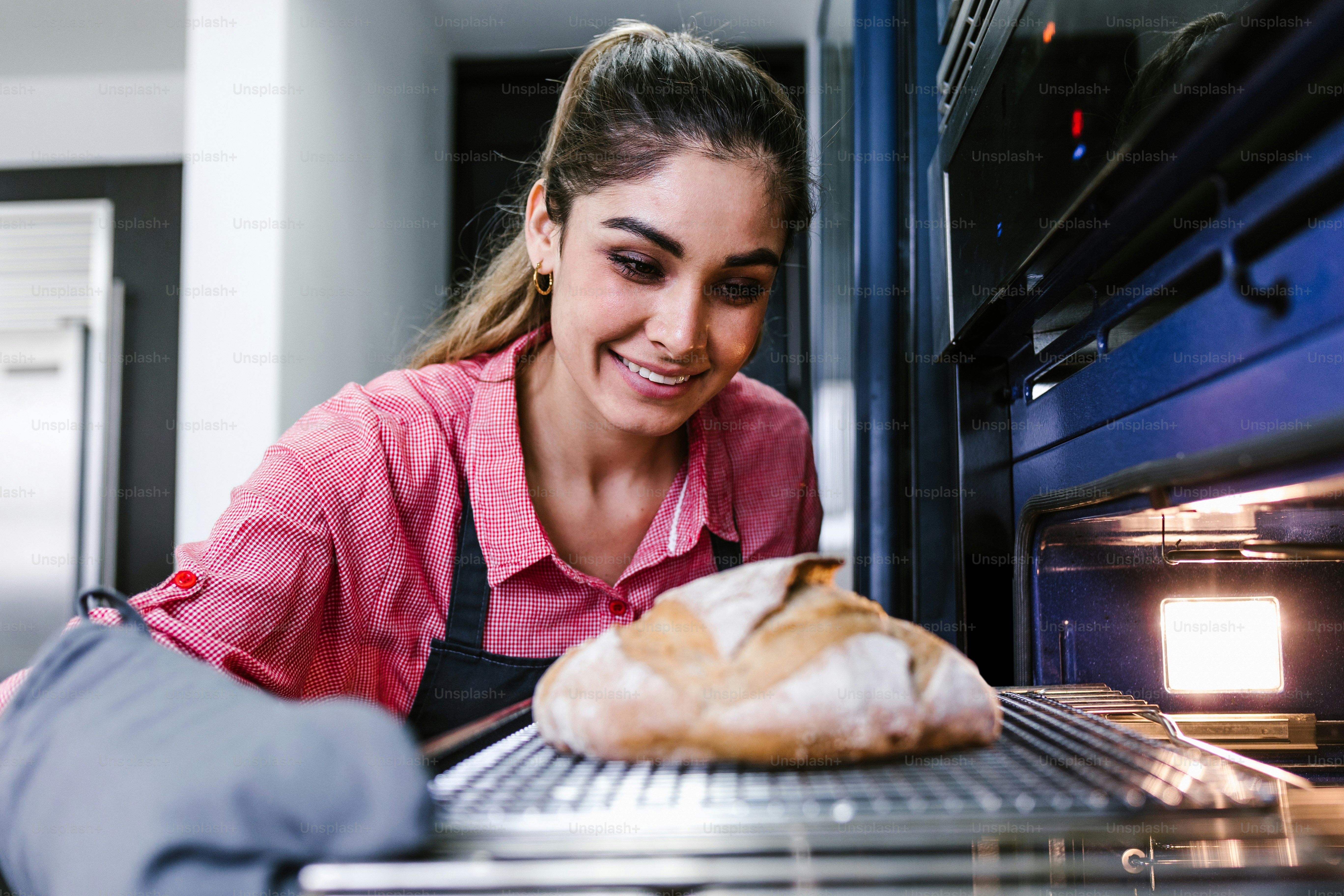 Young Latin woman baking bread and ingredients in kitchen in Mexico ...