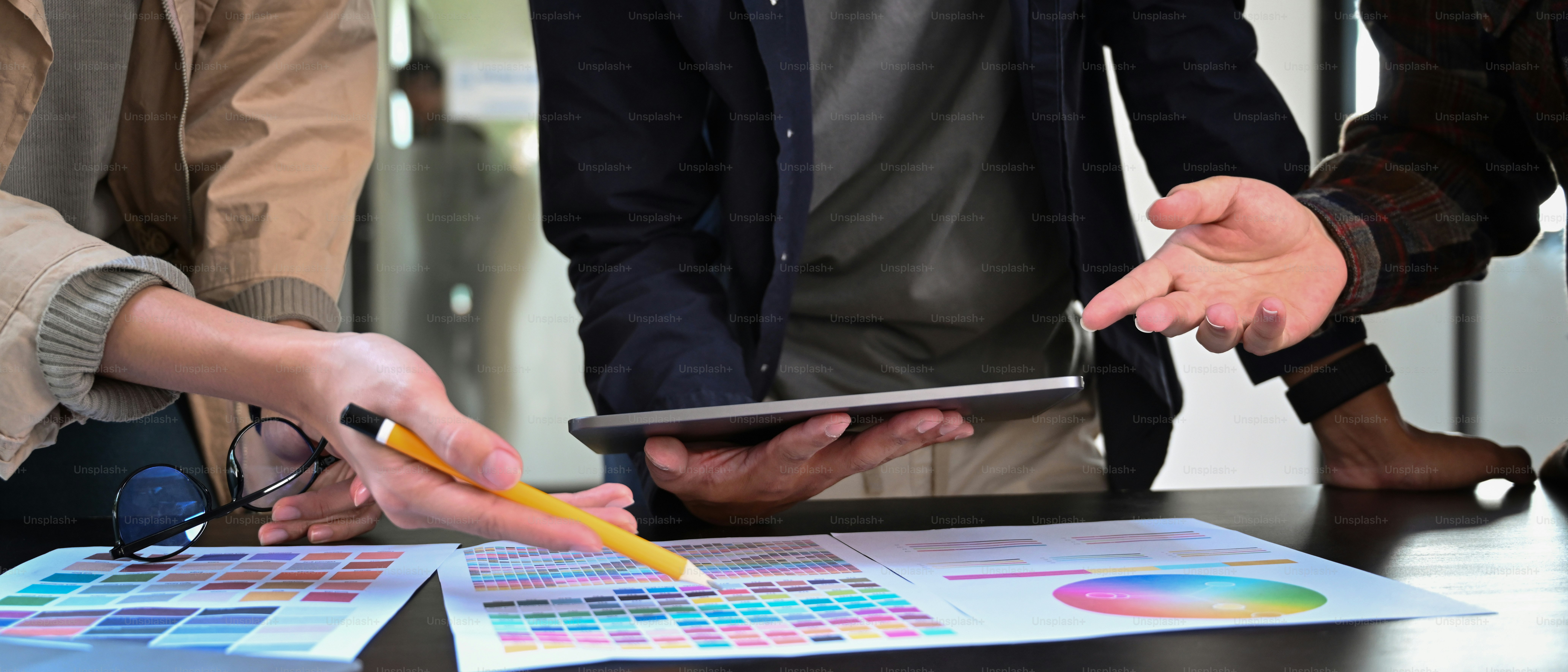 Cropped shot group of creative people working together in office. photo ...