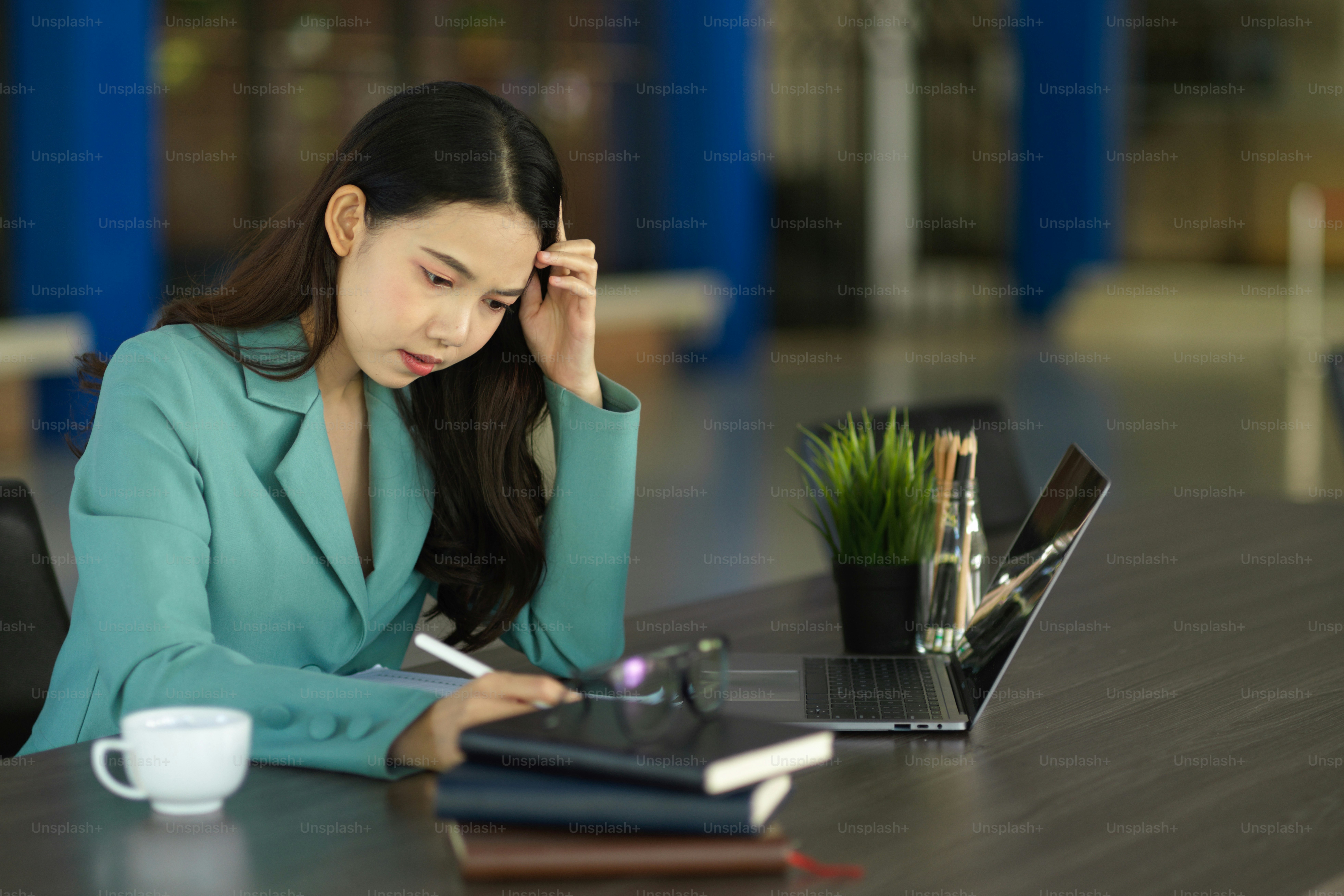 Stressed professional female manager working on her project in the ...