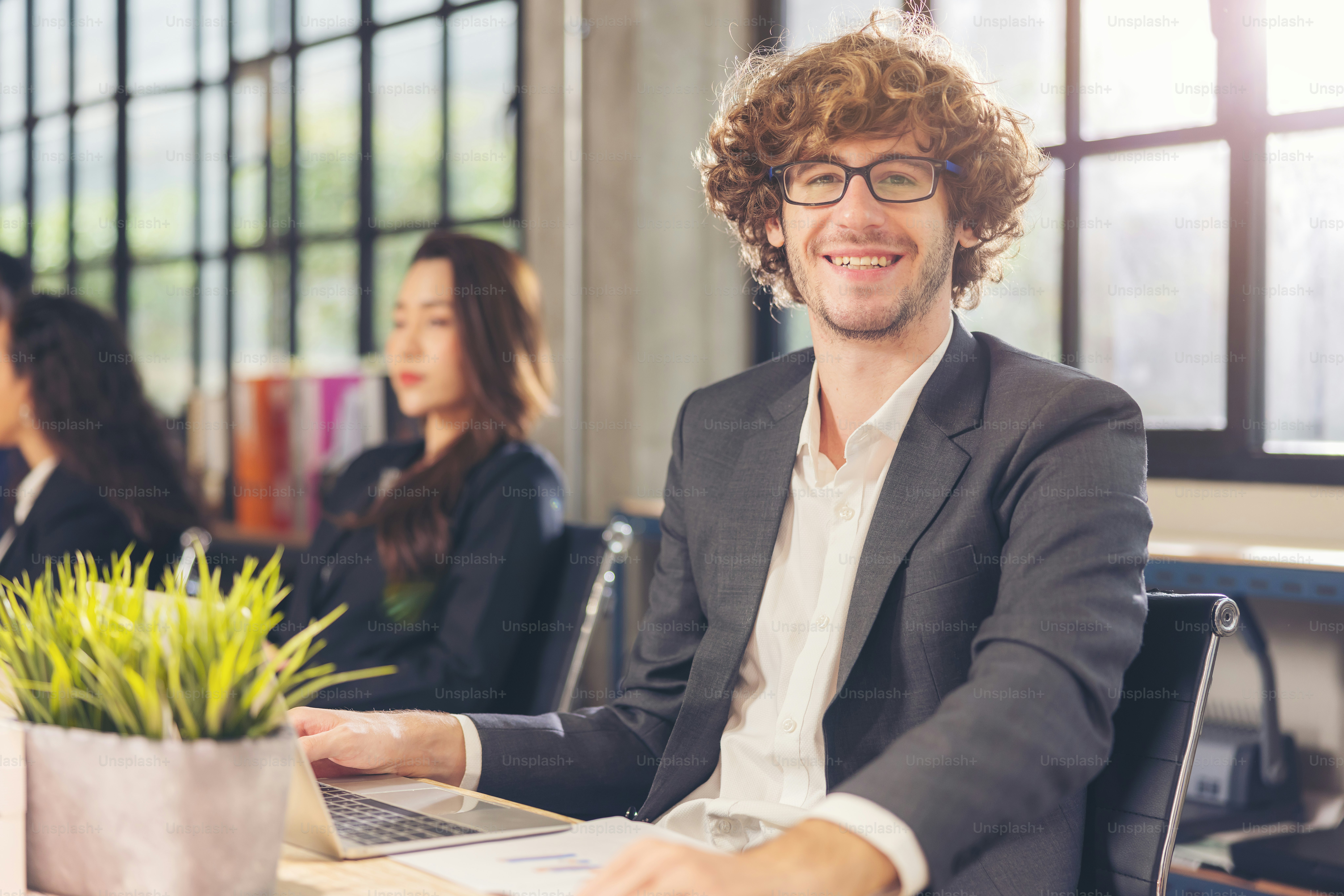 Portrait of a happy caucasian male employee posing for a corporate ...