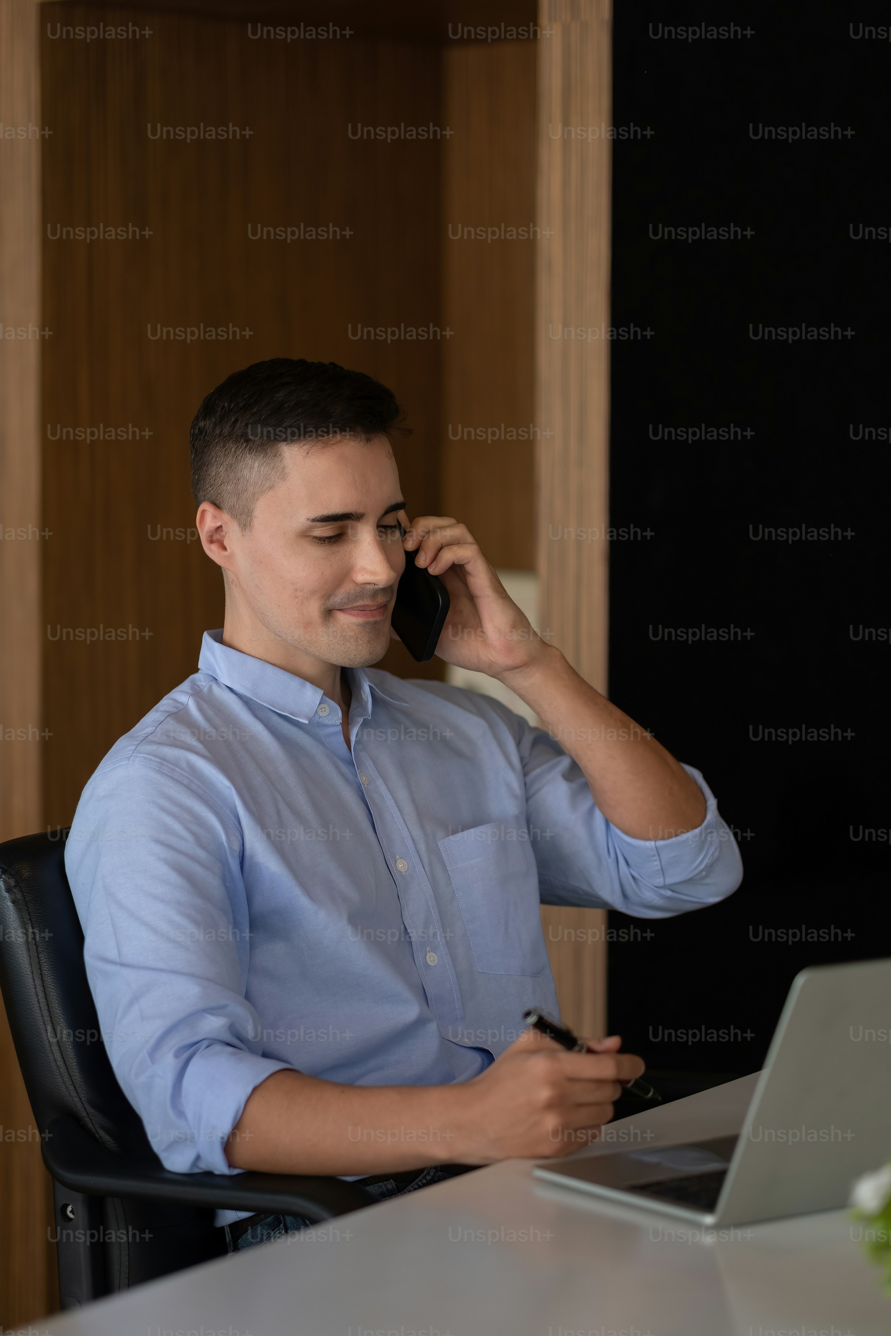Portrait of young smiling cheerful entrepreneur in modern office making ...