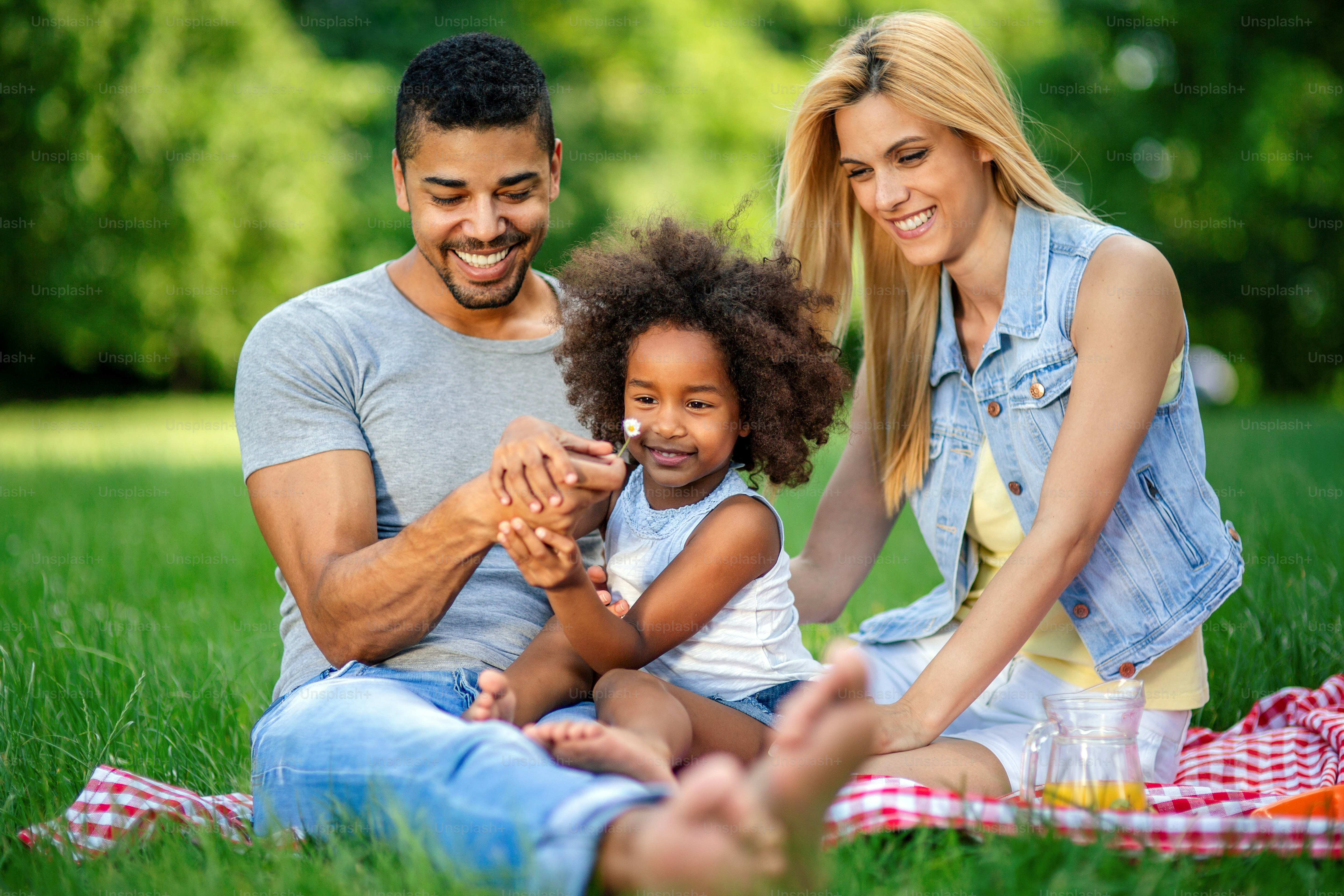 Happy young multiethnic family enjoying picnic in nature photo – Family ...