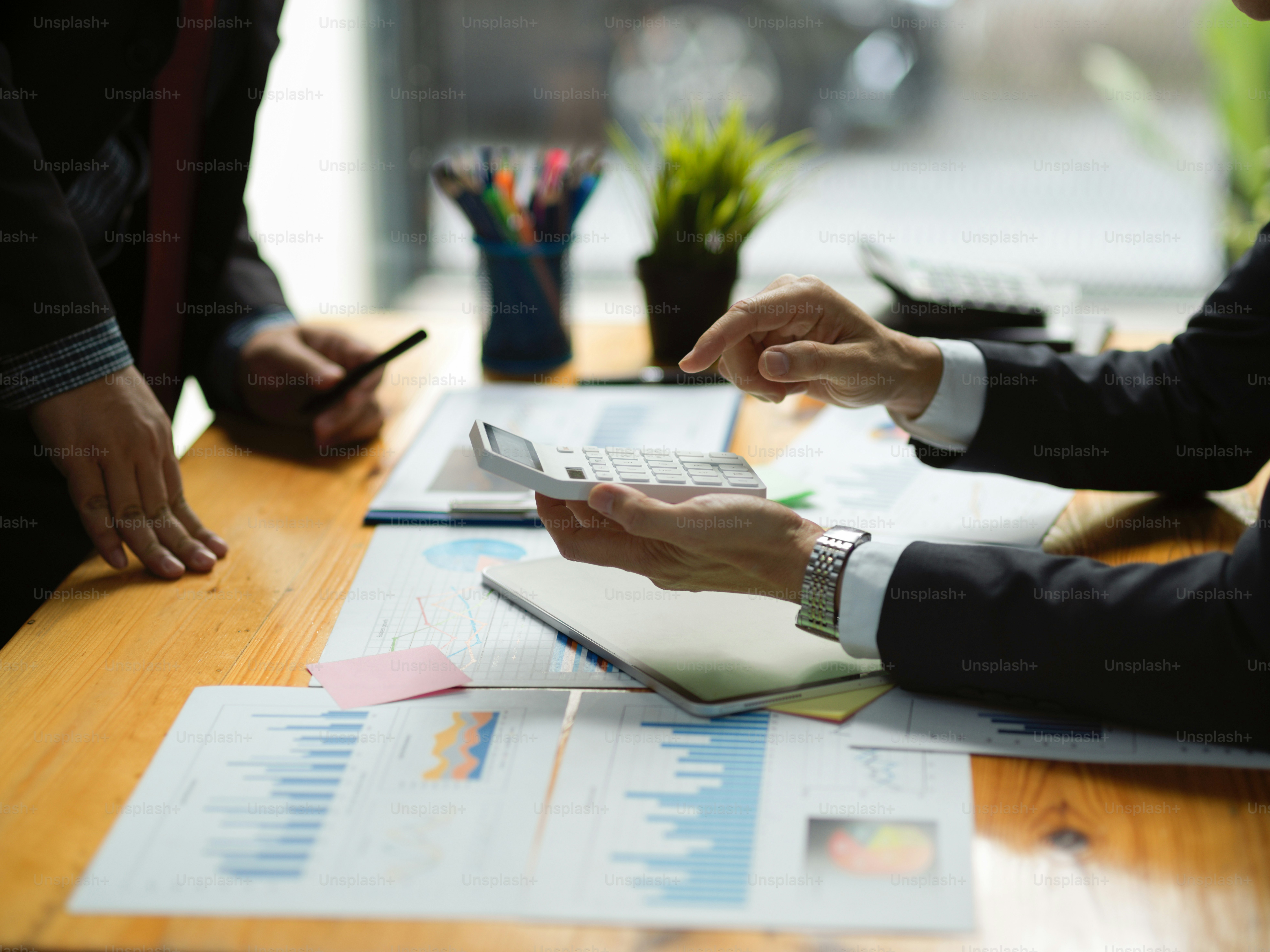 Successful male boss consulting with his marketing and financial worker ...