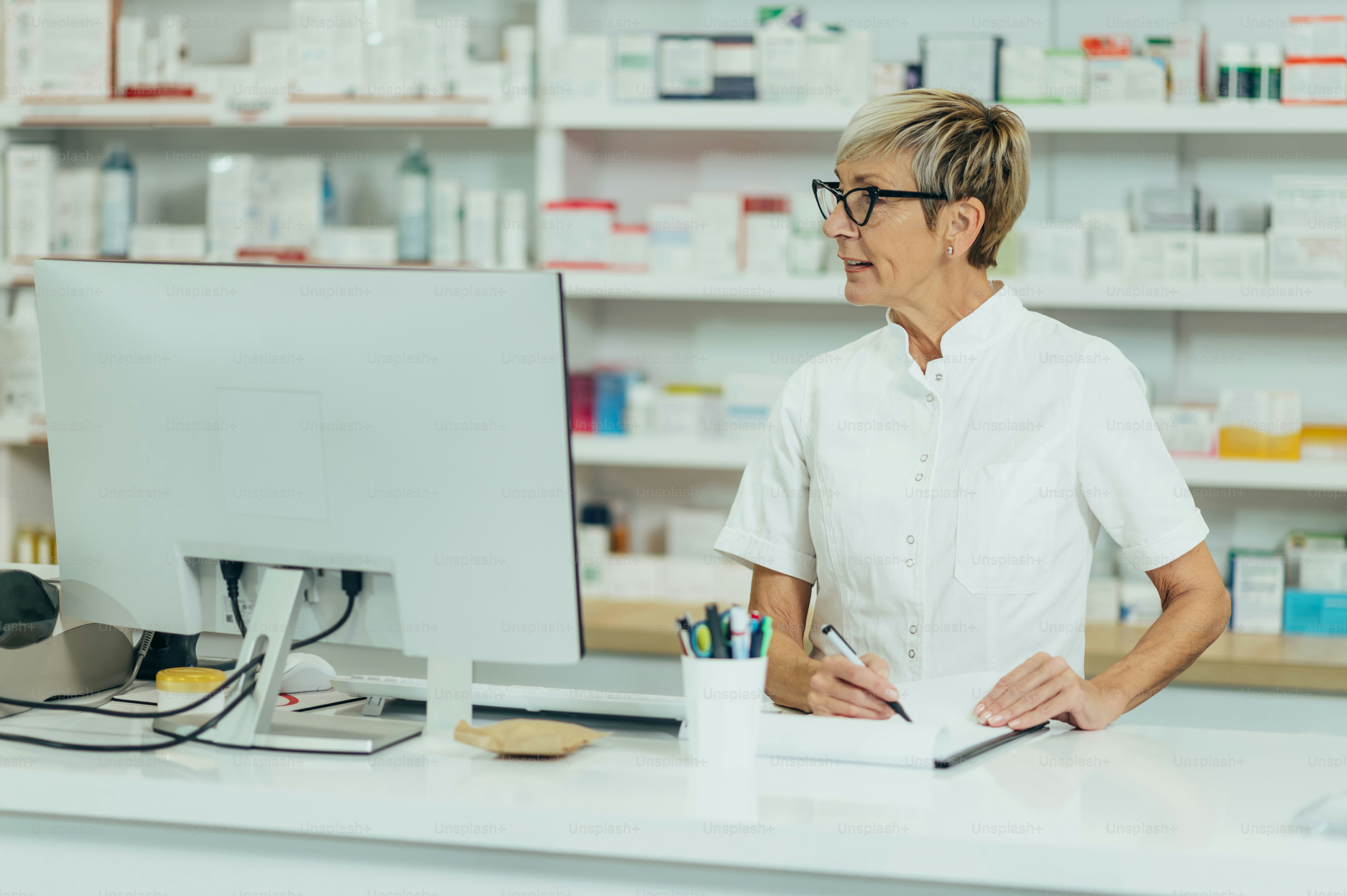 Portrait of a beautiful senior female pharmacist working in a pharmacy ...